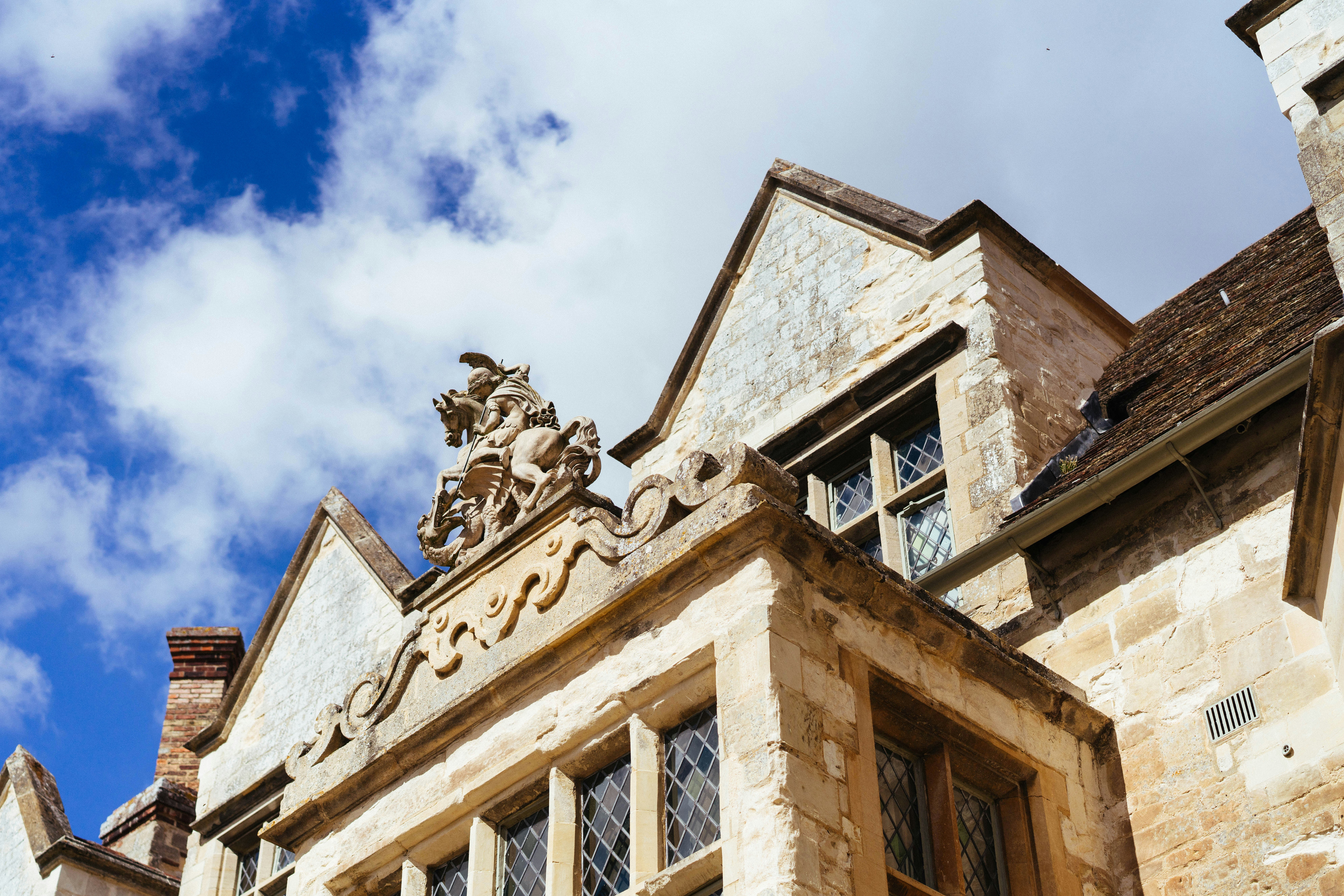 Sunlit Crest: Historic Facade Reaches Toward a Blue Sky