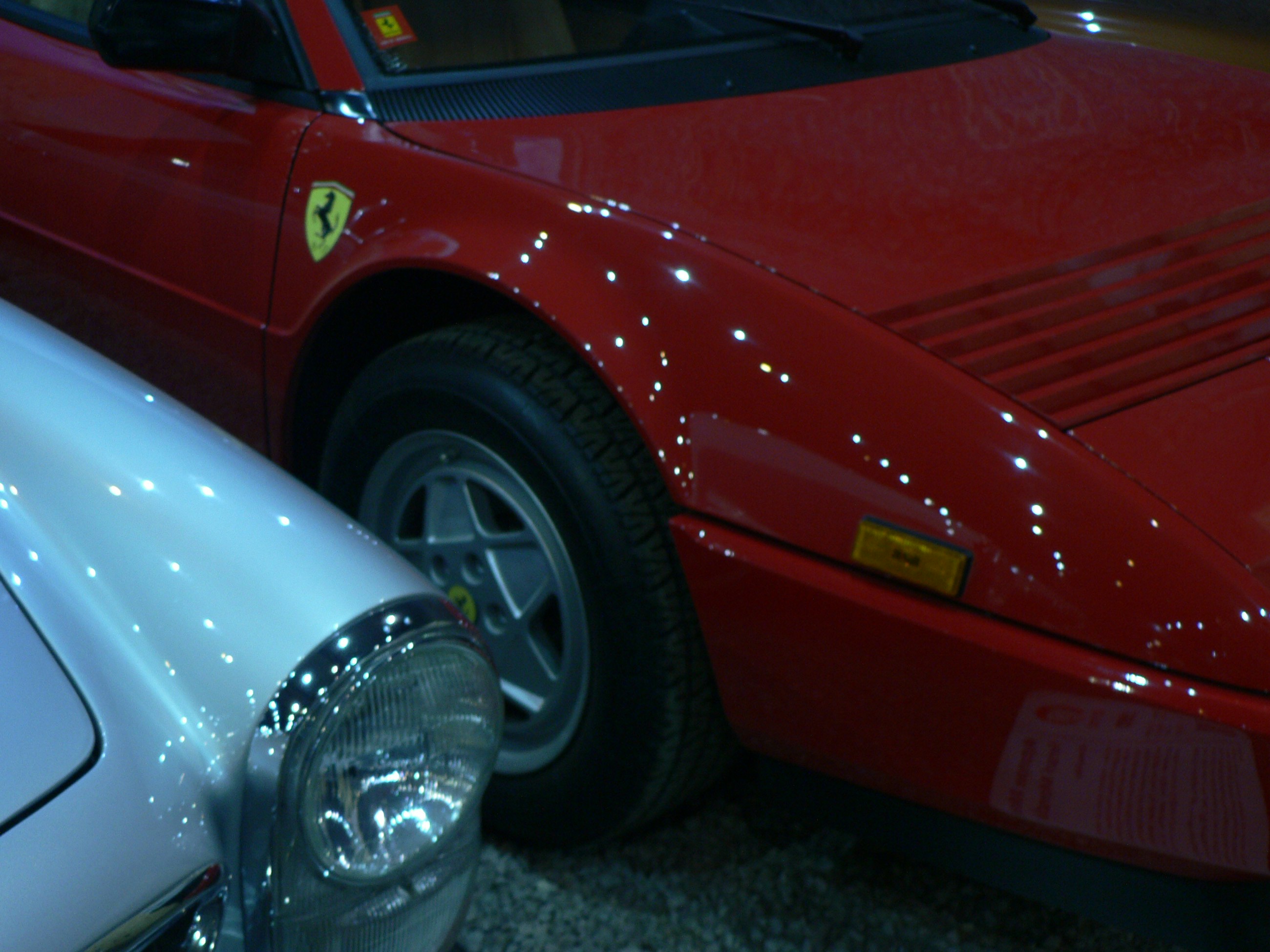 Red Ferrari Mirage: Framed by a Silver Headlamp