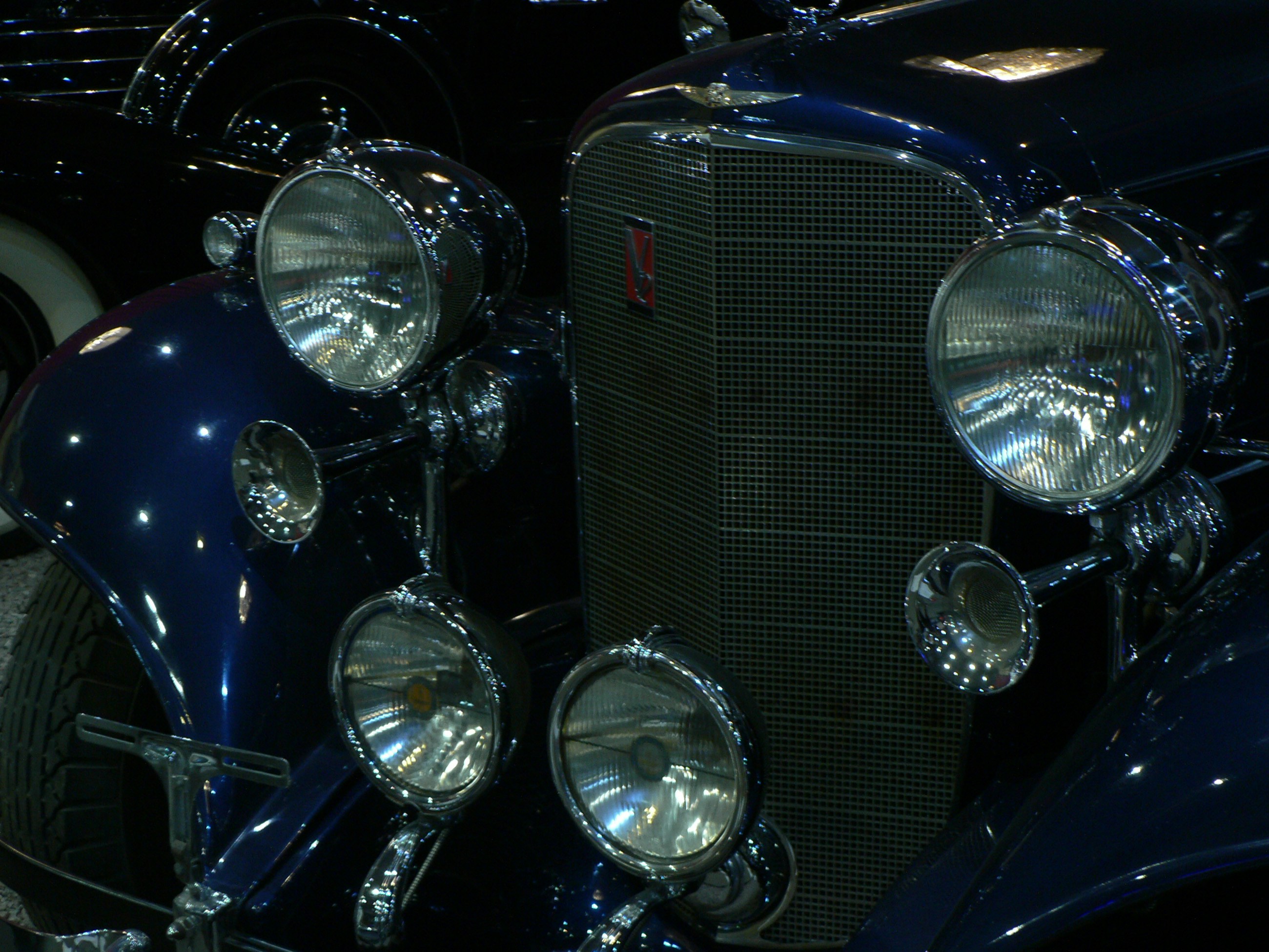 Chrome Echoes: A Blue Classic Grille Stares Back