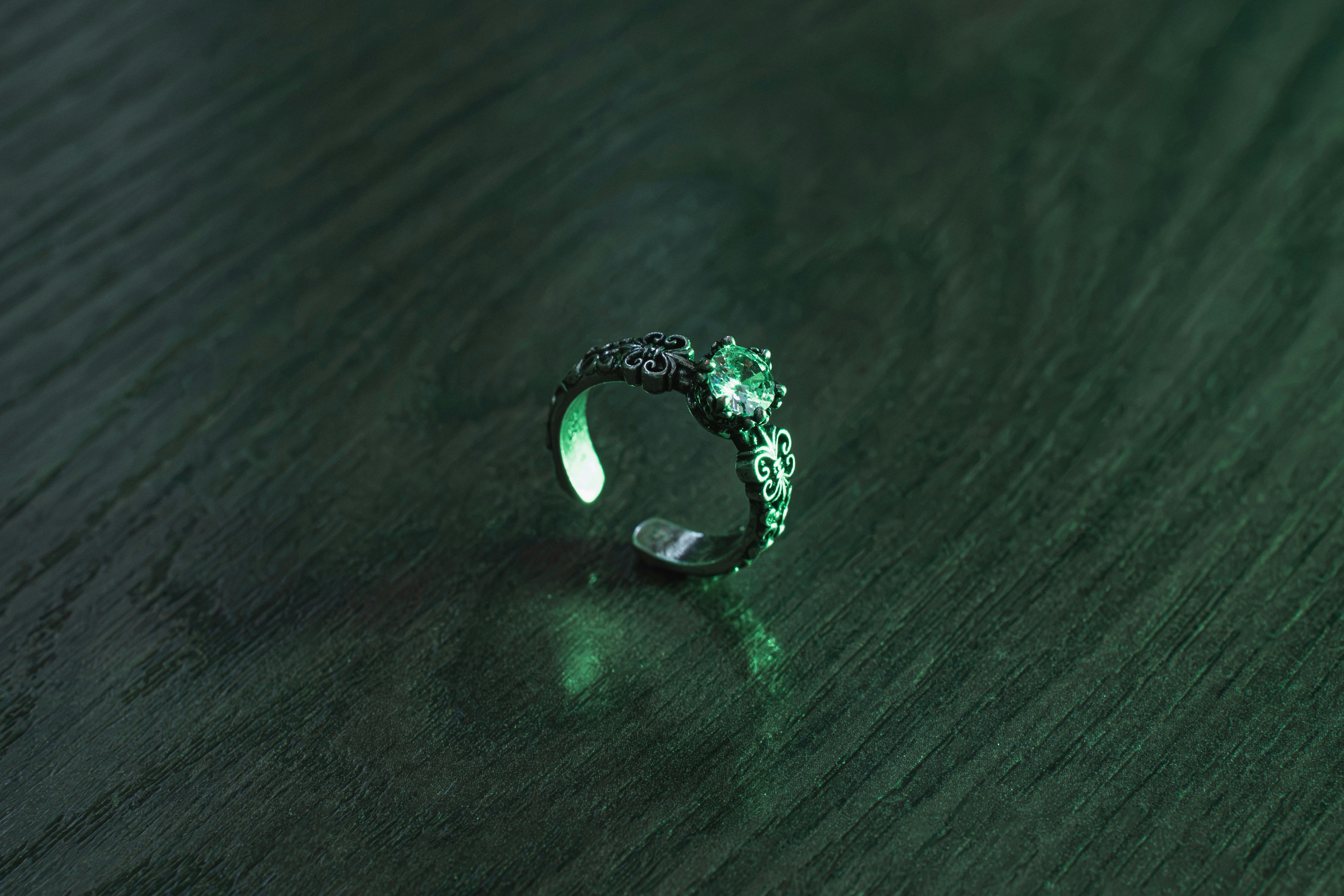 Emerald Ring on a Velvet Surface: A Subtle Spark of Green