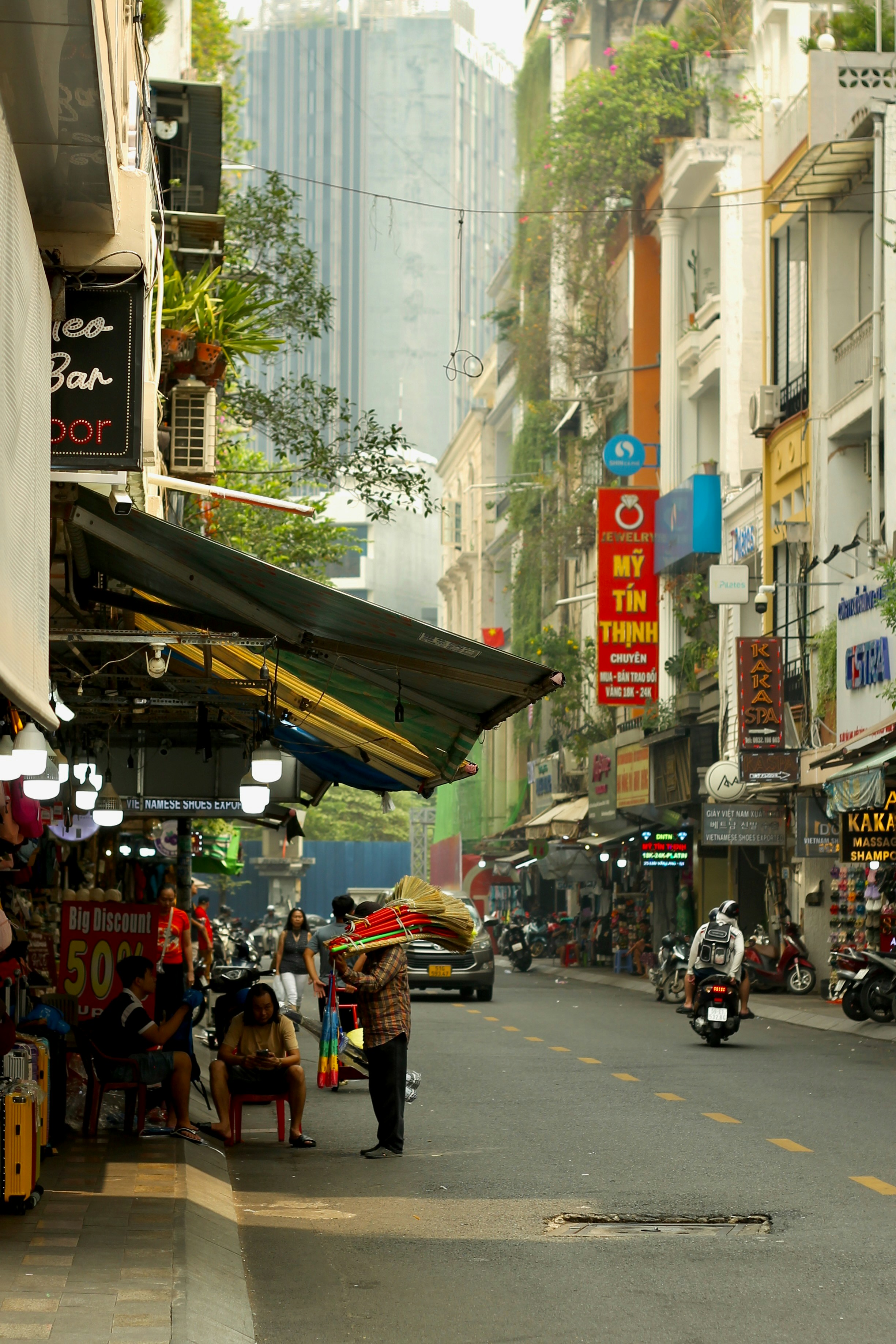 Street Market Currents: A Narrow Lane Between Signs and Shelter