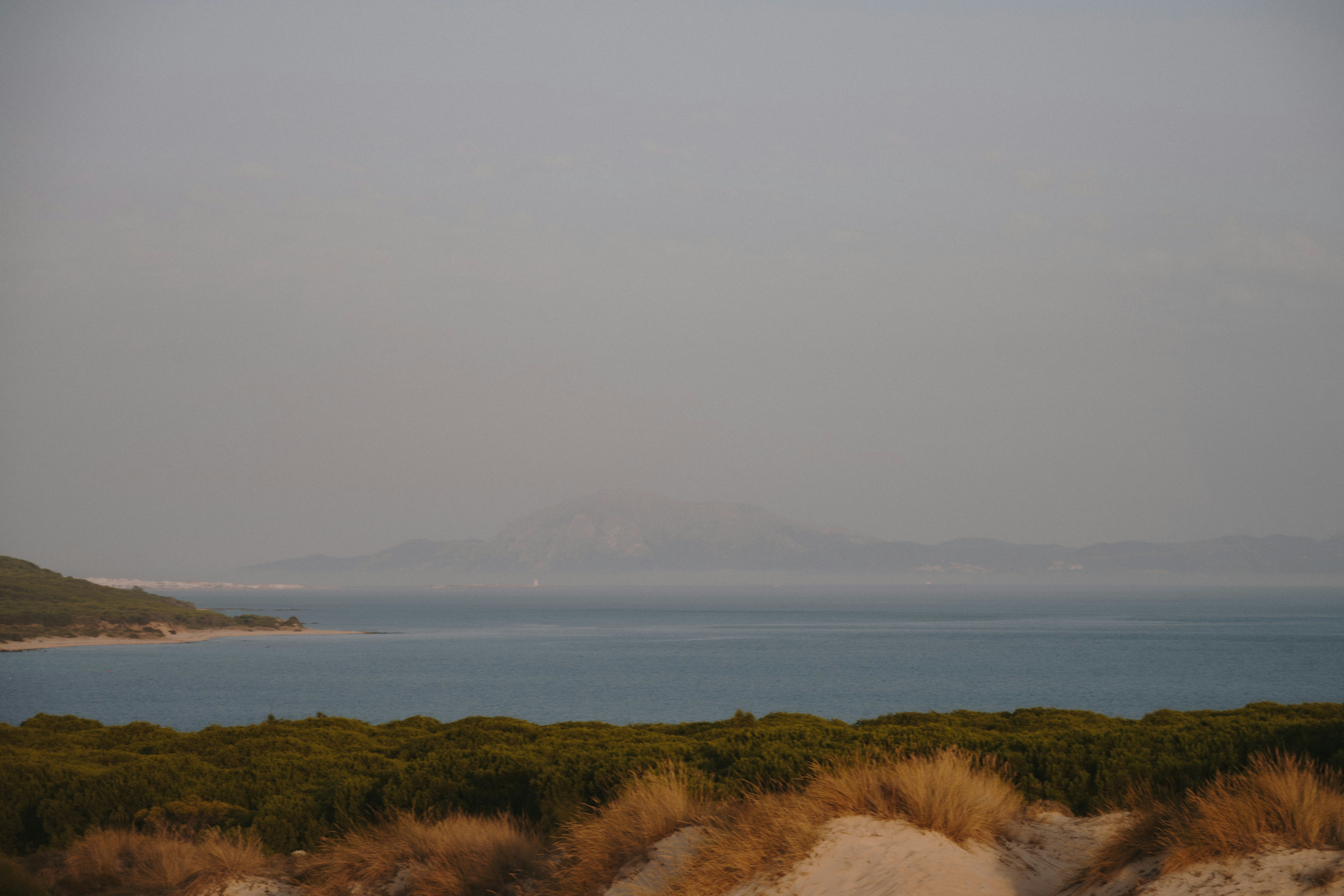 Distant Island Whisper: Calm Sea Beyond Coastal Dunes