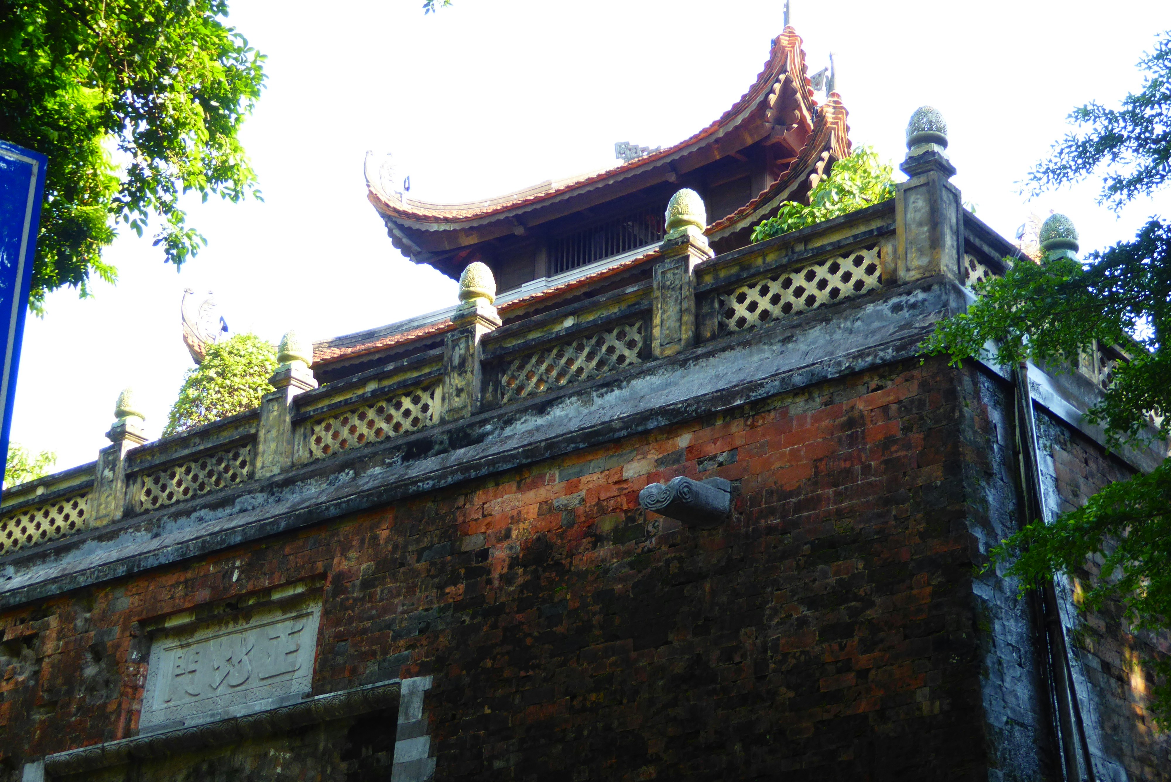Brick Gate and Curved Roofline Above Shadowed Terrace
