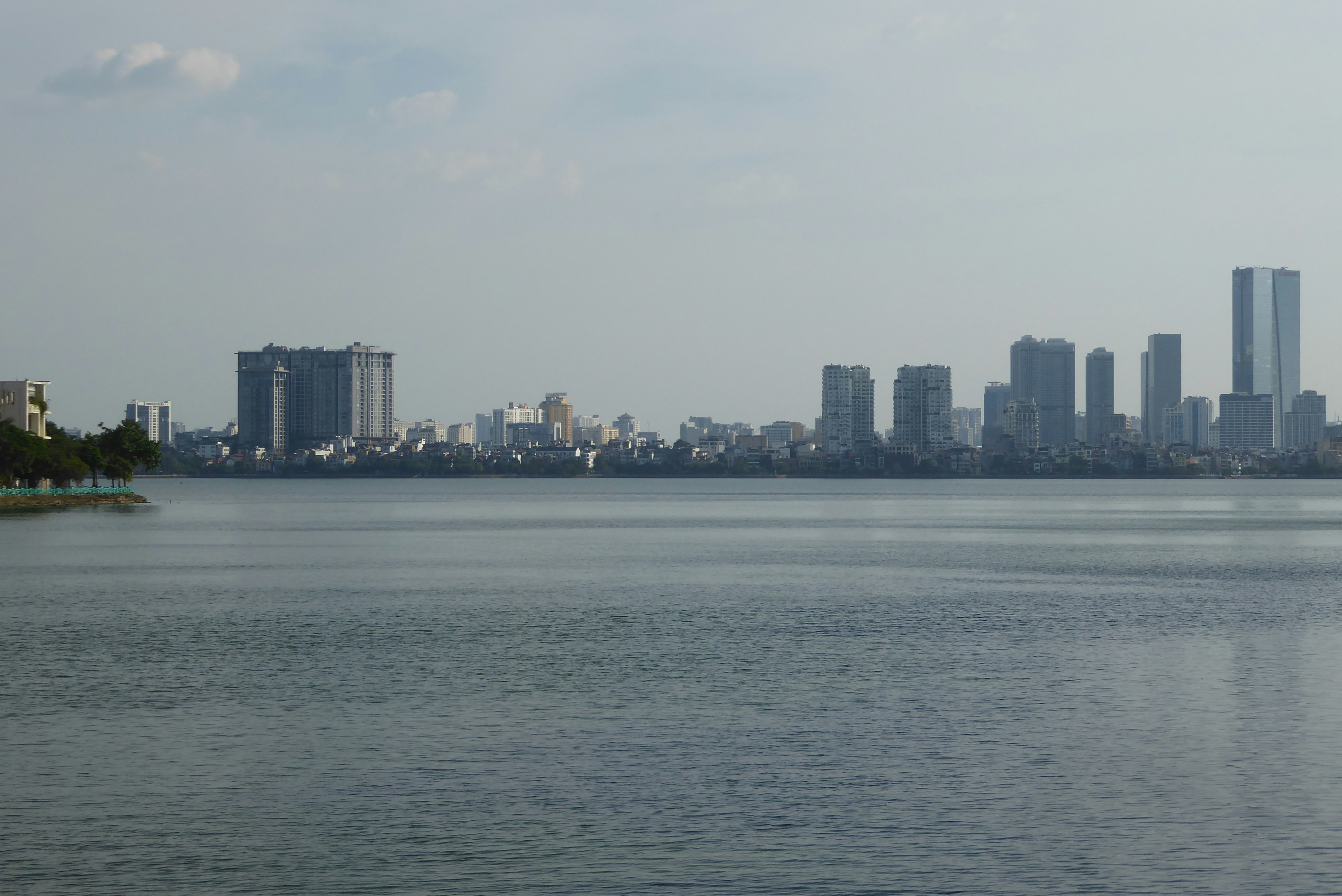 Urban Waterfront Silhouette: City Skyscrapers Rising Over Calm Waters
