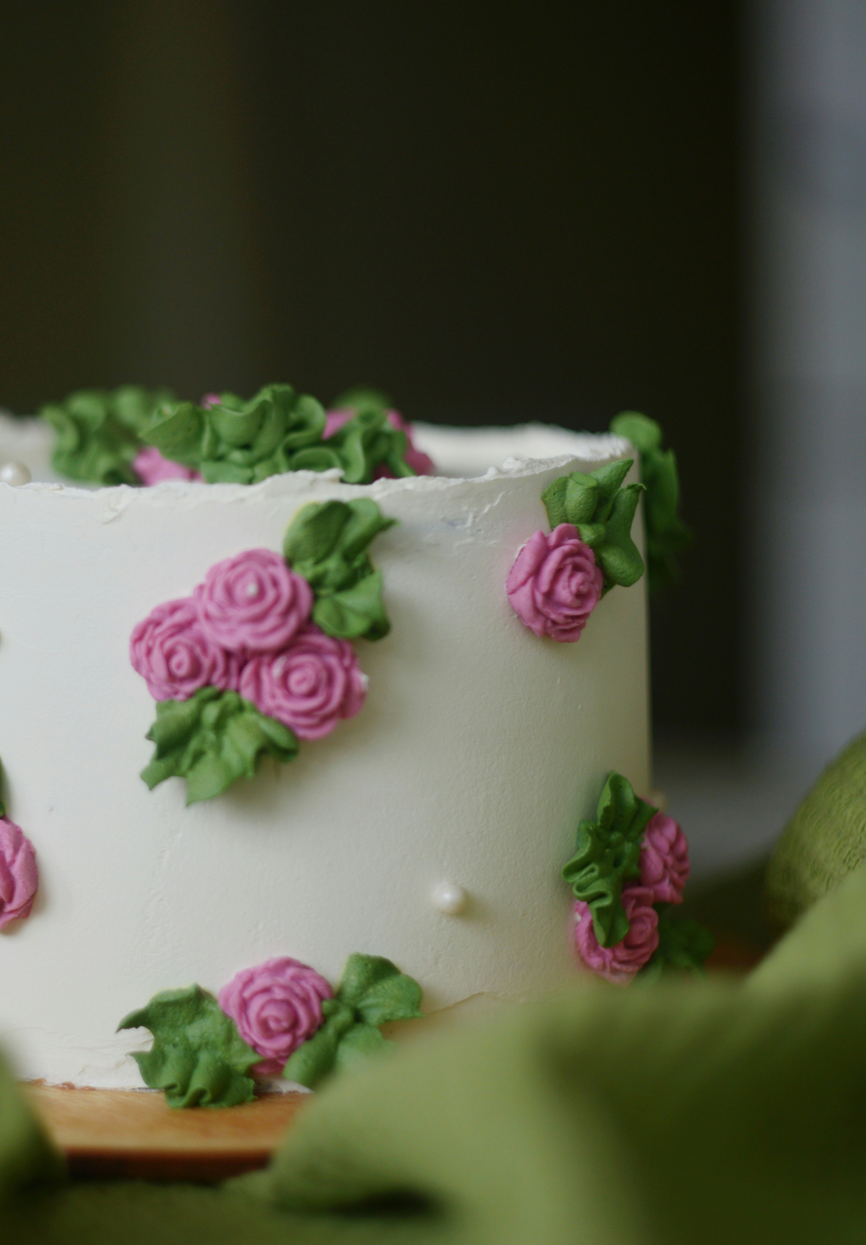 Pink Rosettes on White Velvet: A Cake in Focus