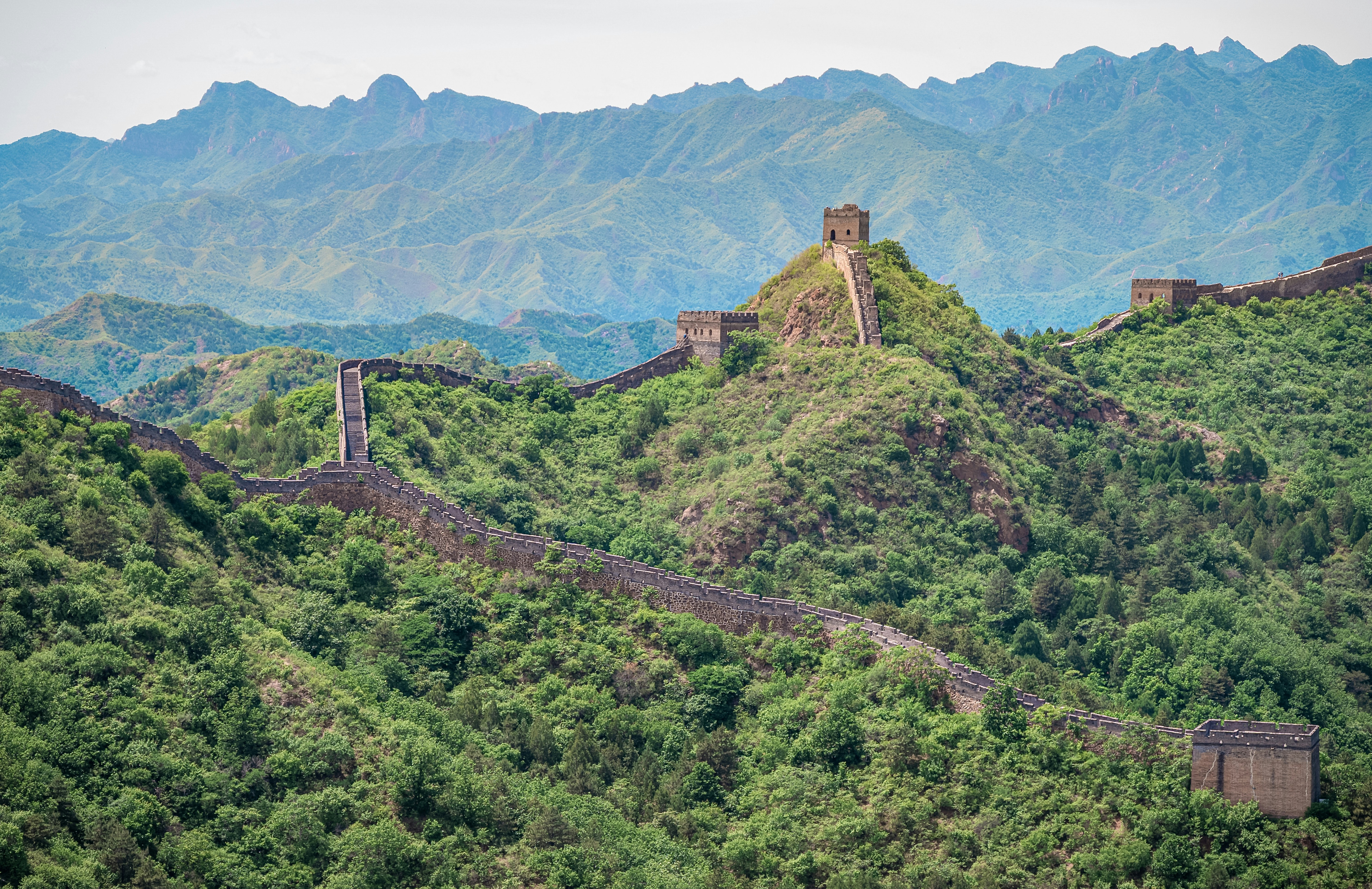 Rising Watchtowers along a Serpentine Great Wall Carved into Green Hills