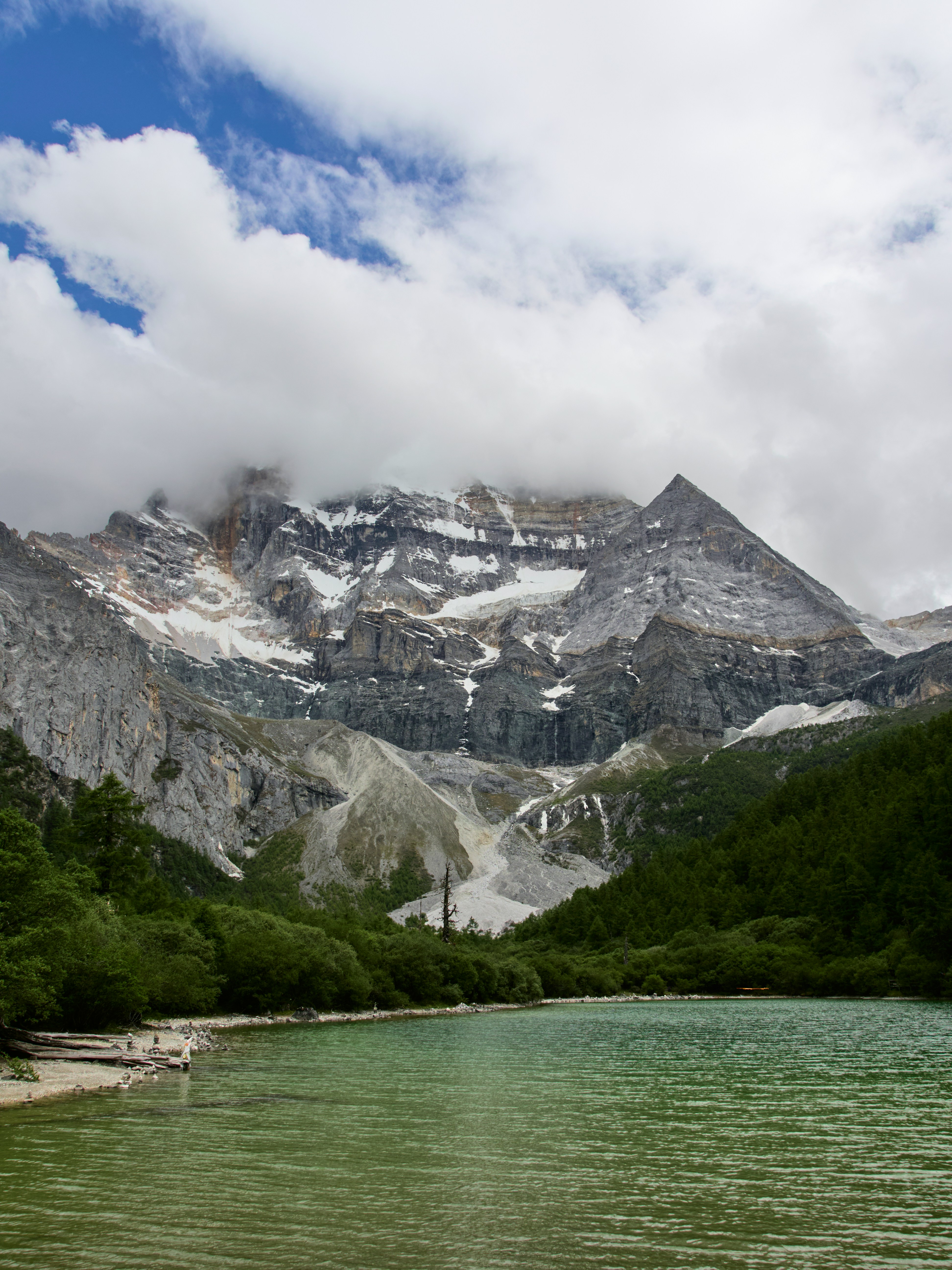 Emerald Glacial Stream Beneath Snow-Capped Peaks