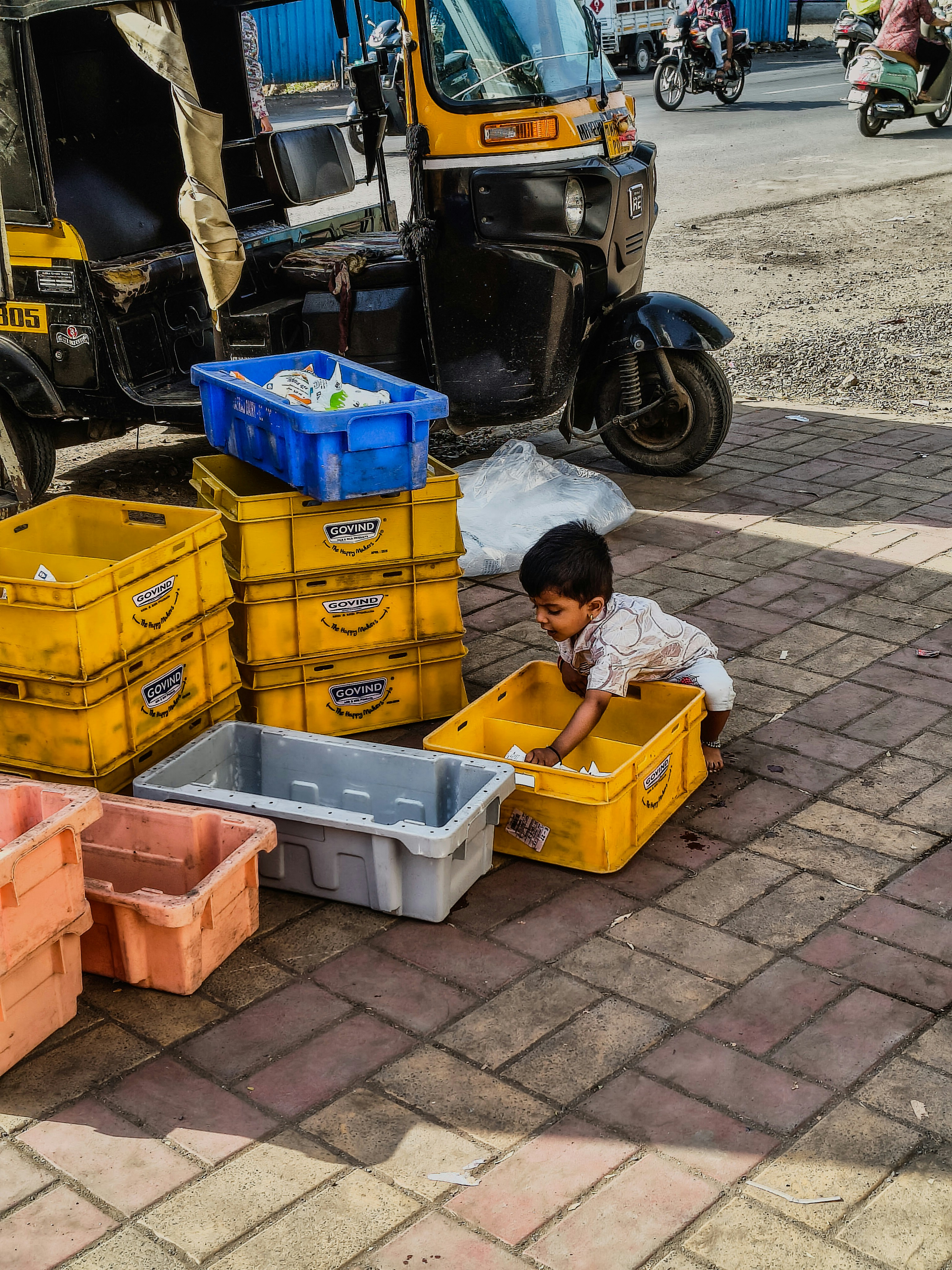 Child at the Market Edge: Crates, Shadows, and a Gentle Moment