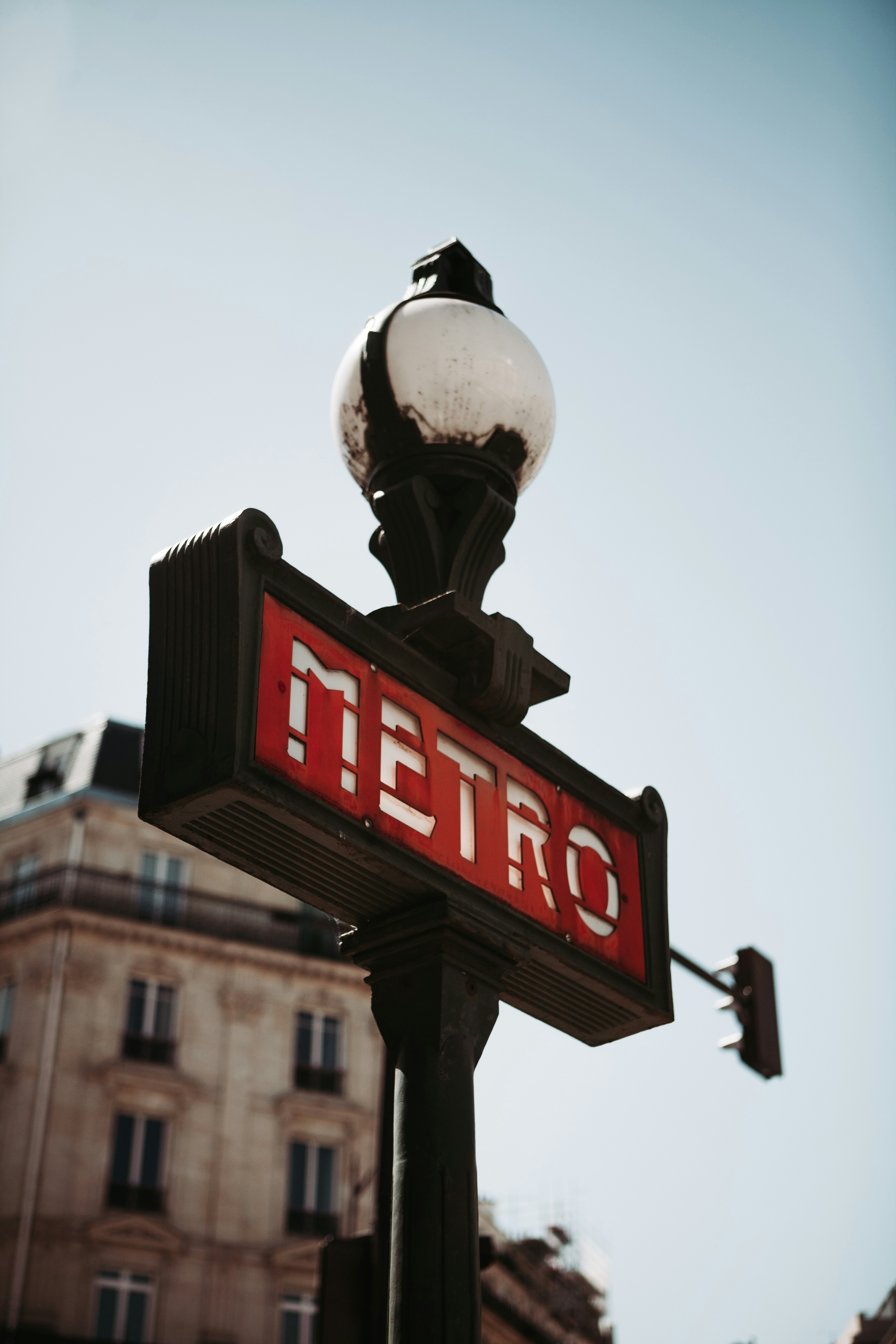 Metro Sign Under a Pale Sky: A Close-Up on Urban Signage