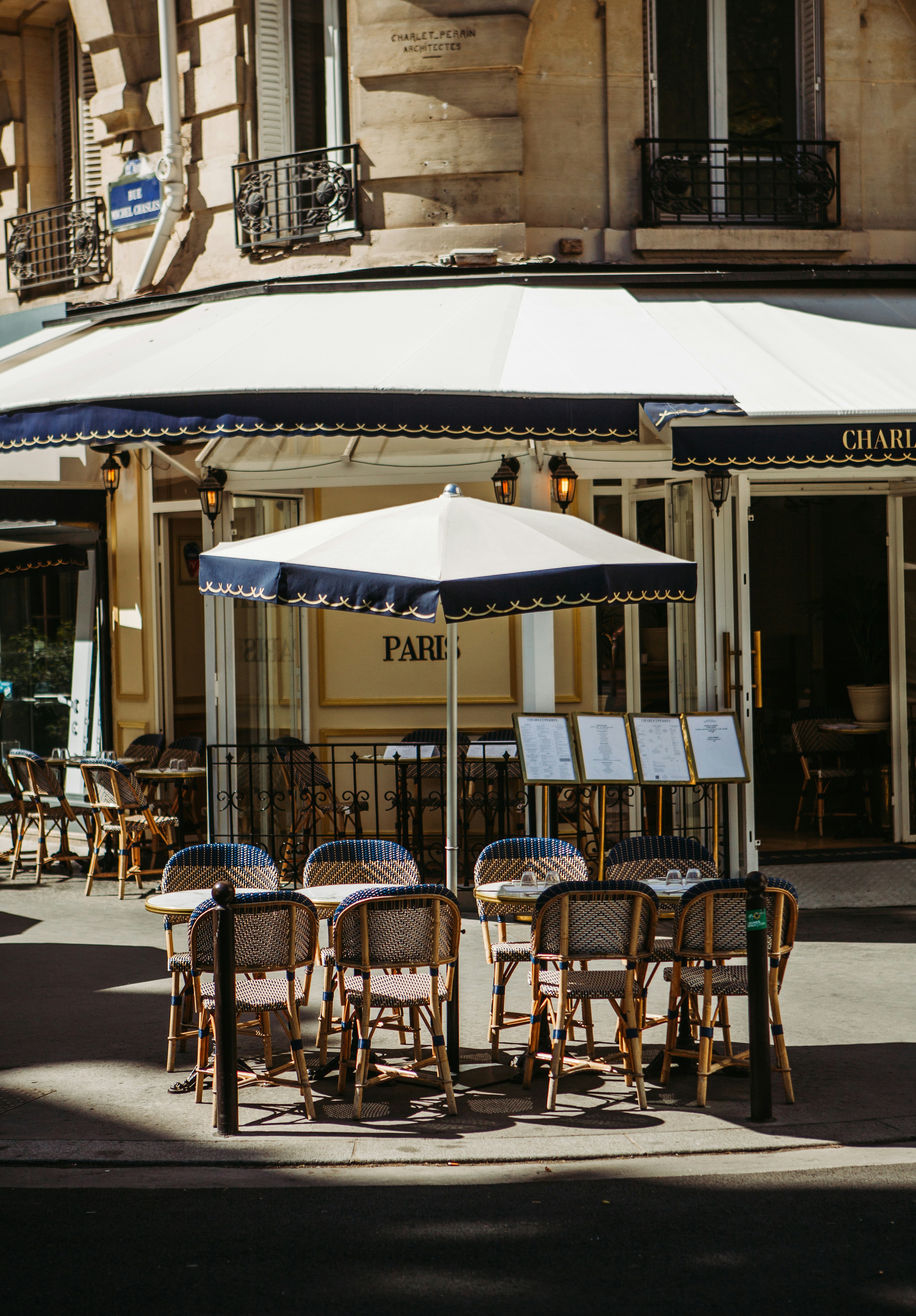 Parisian Café Terrace Beneath a White Canopy