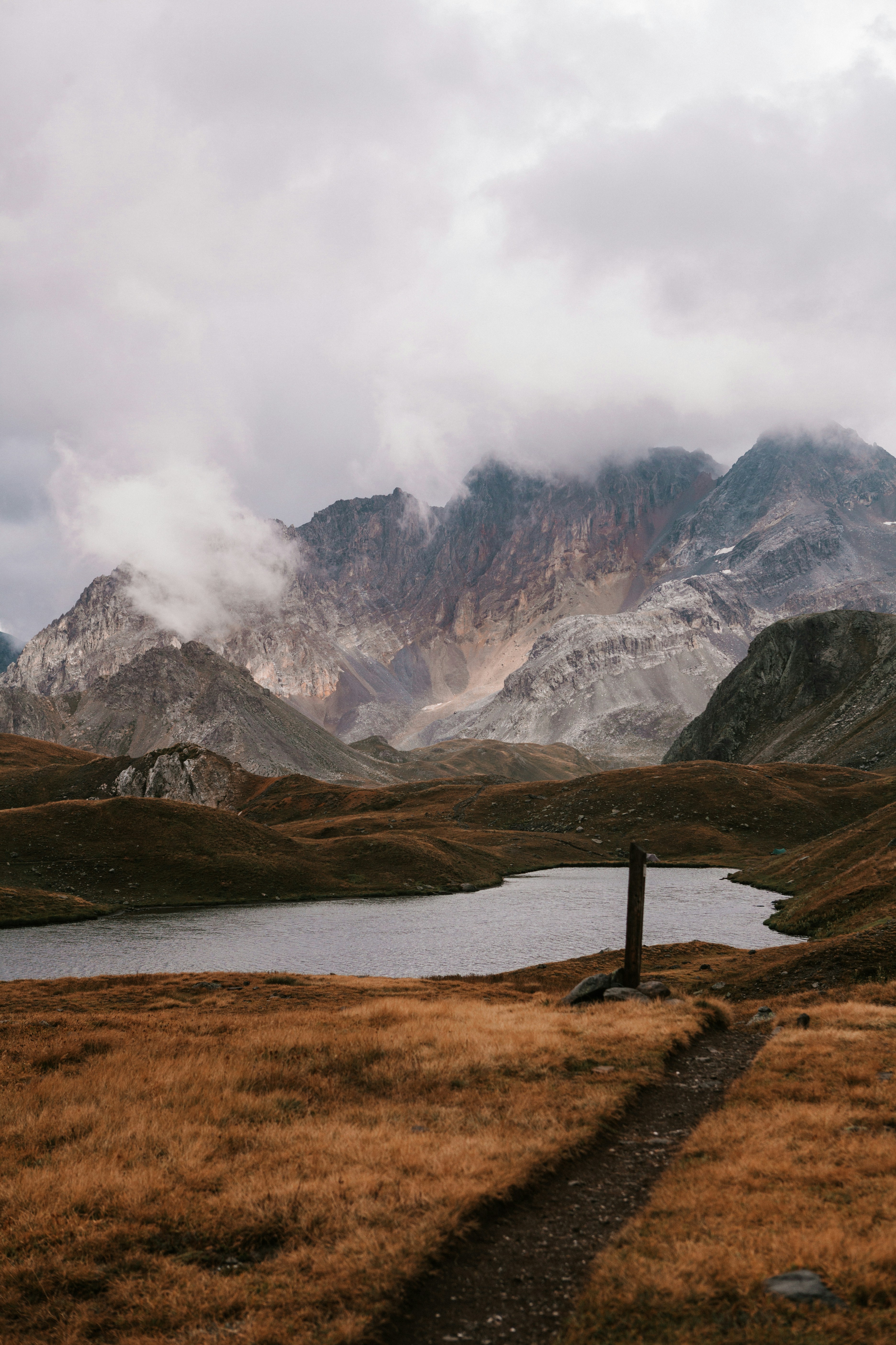 Mist over Cragged Ridges: A Solitary Path to the Lake