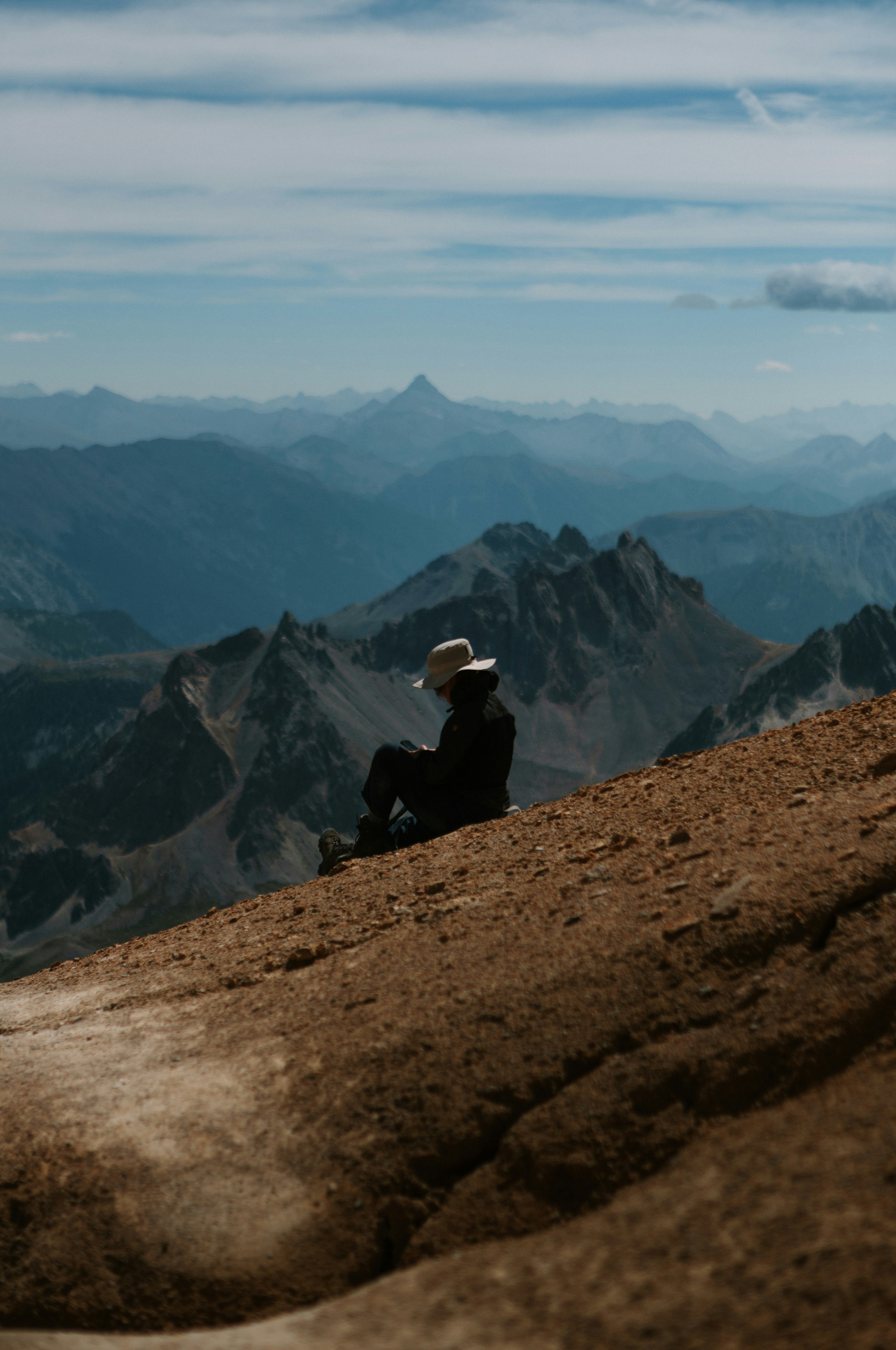 Silhouette on a Ridge: A Solitary Solstice Amidst Jagged Peaks