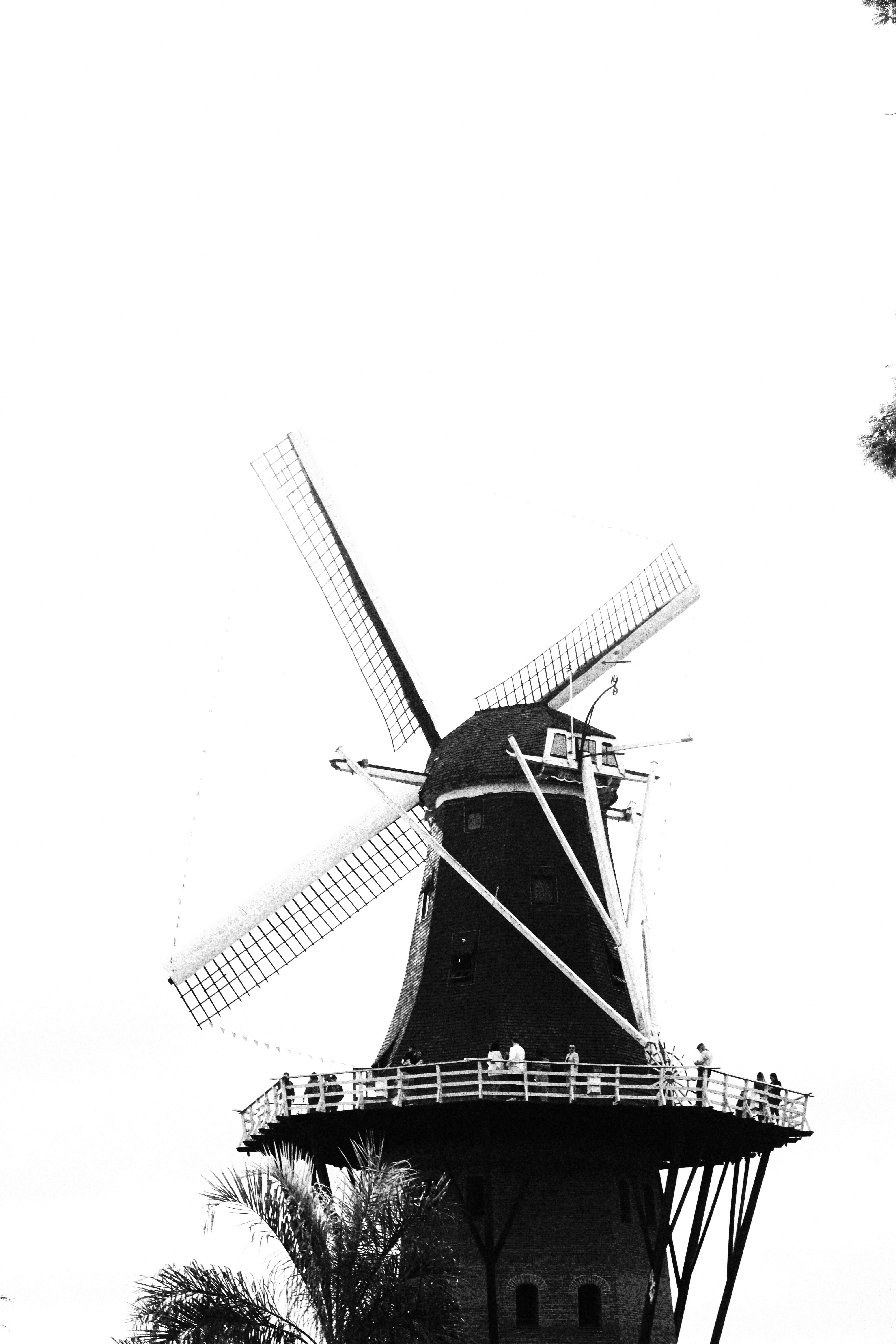 Towering Windmill silhouette against a bright sky