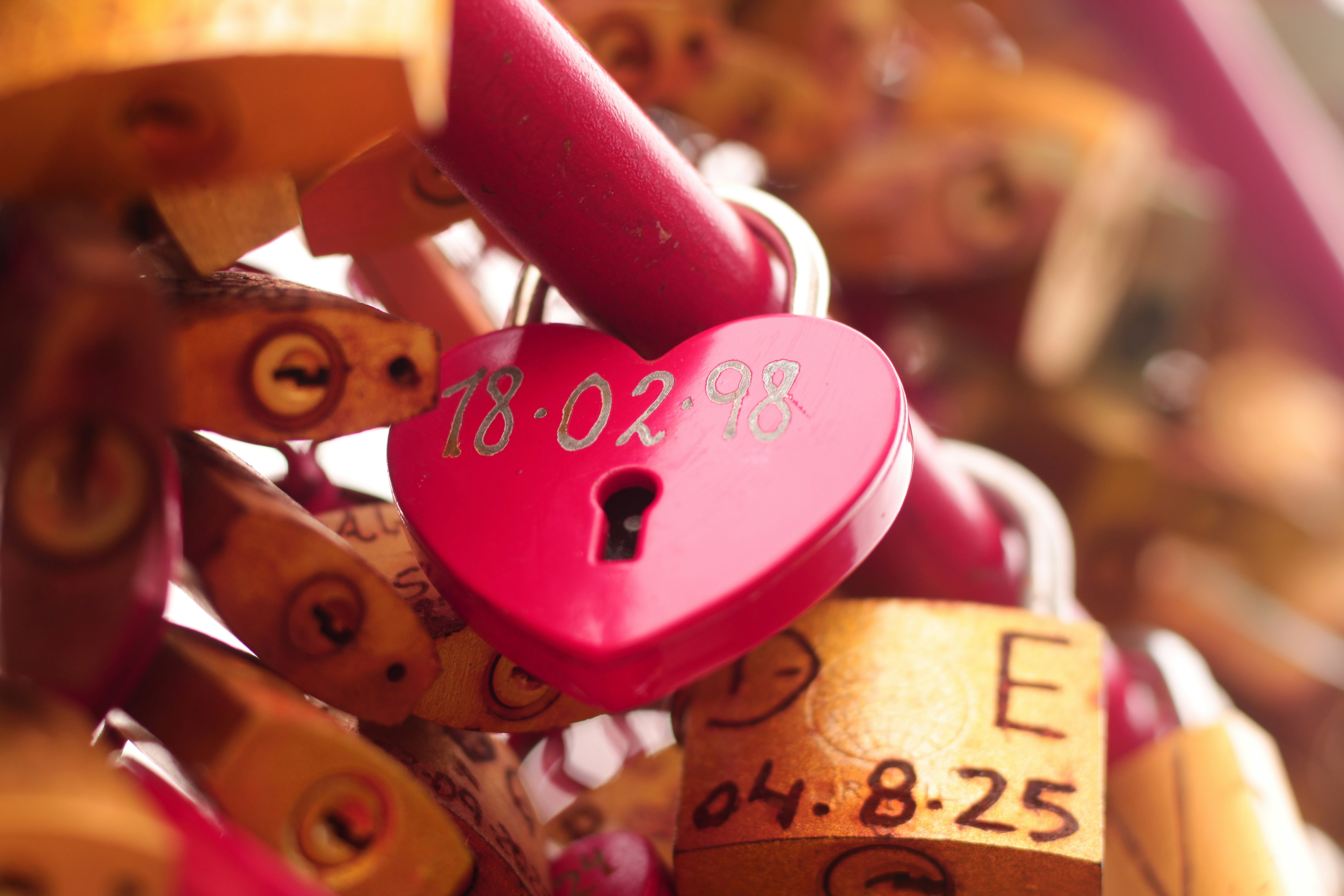 Locks of Forever: A Heart-Shaped Padlock Among Yellowed Ribbons