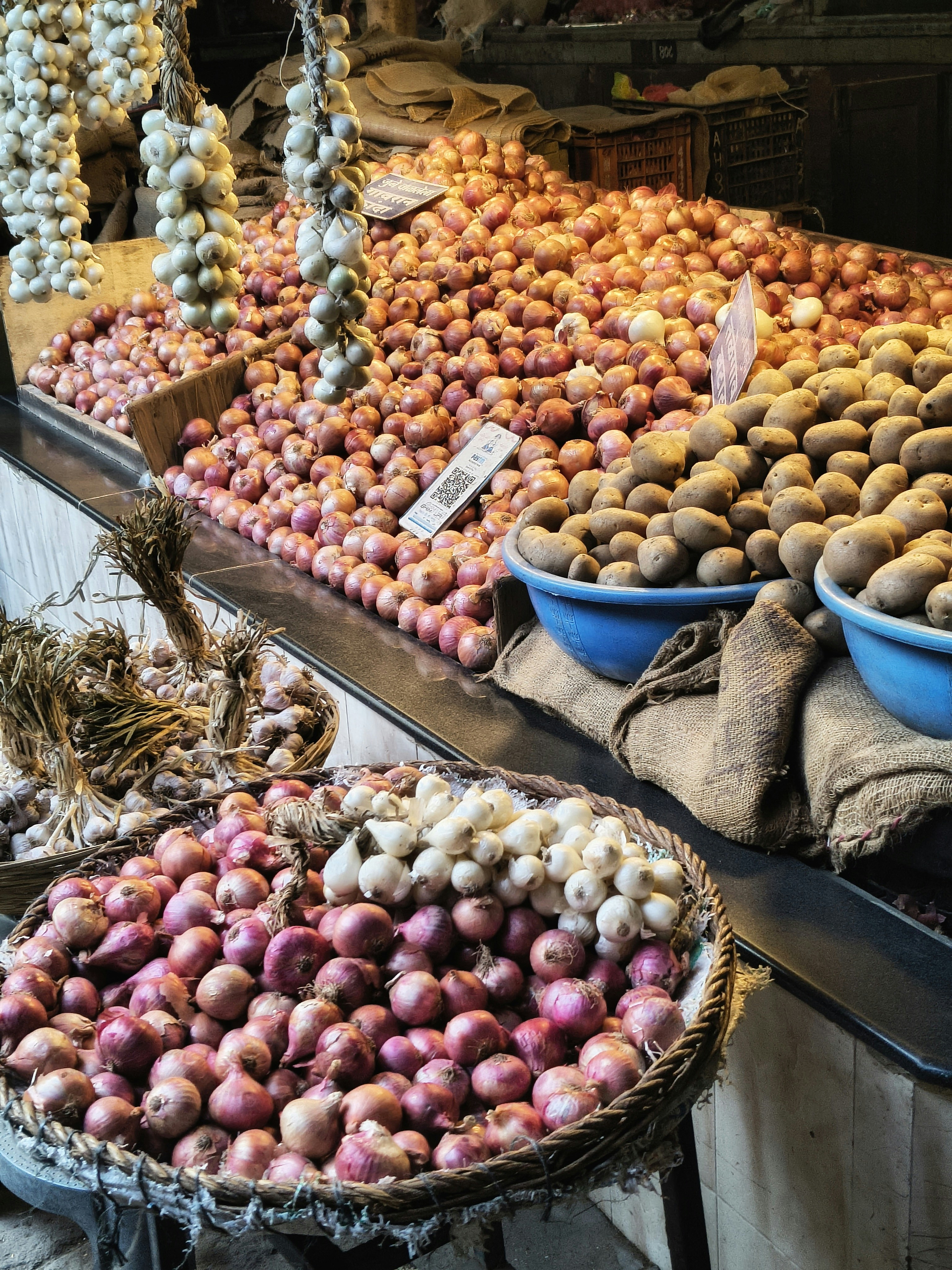 A Bountiful Market Stall: Golden Row of Onions and Potatoes