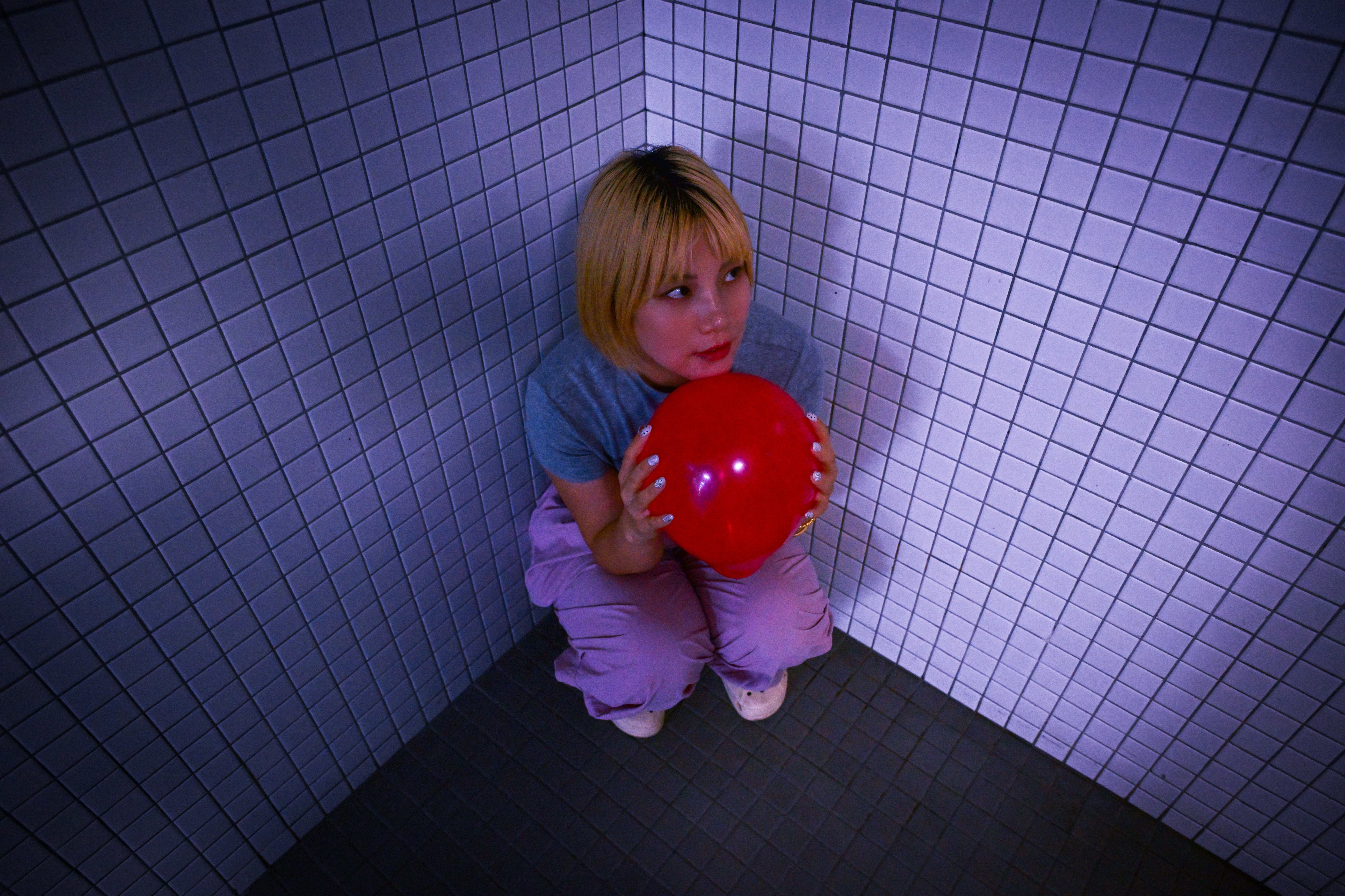 Balloon in the Corner: A Quiet Moment Between Wall Tiles
