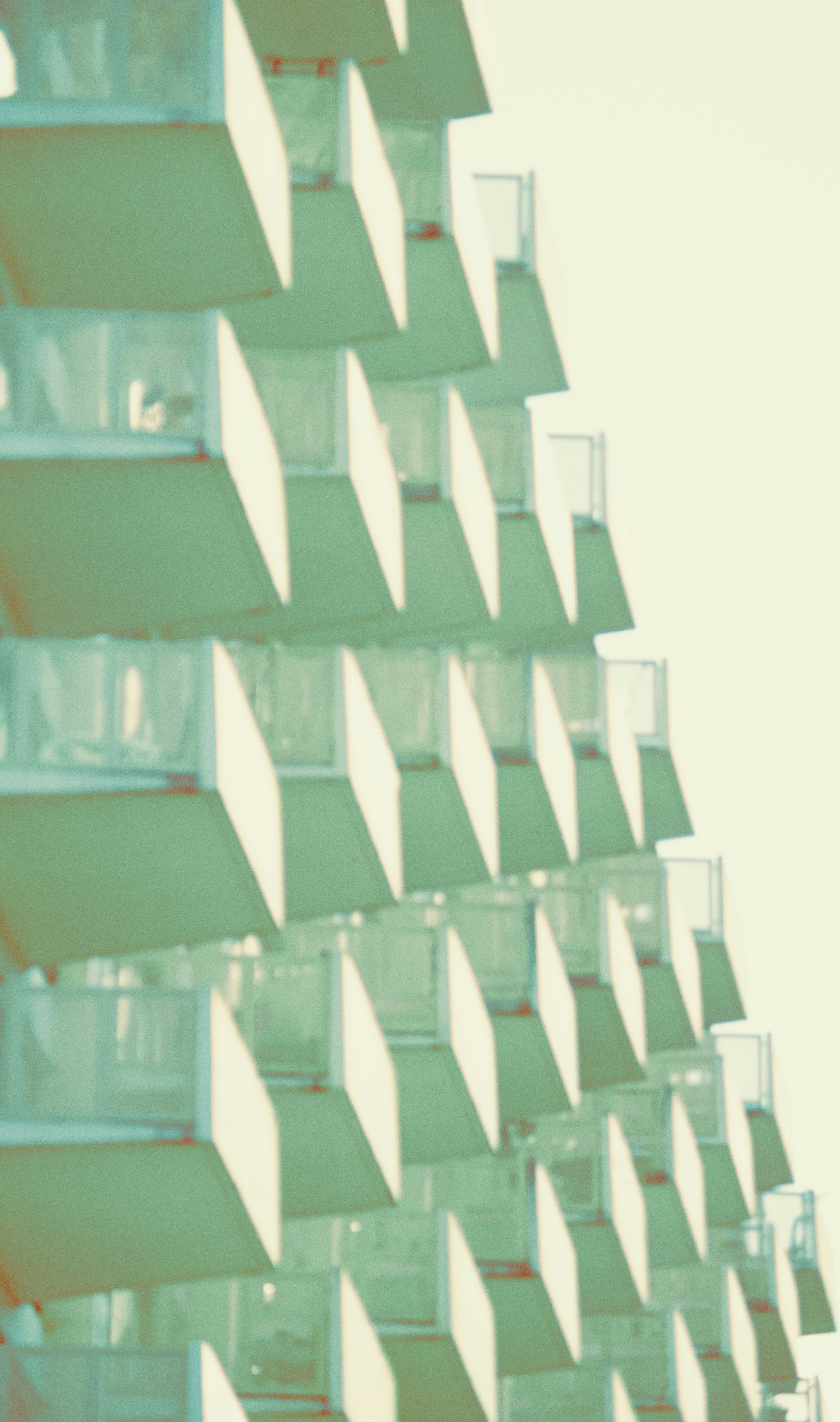 Vertical Echoes: Repeating Balconies in Muted Mint