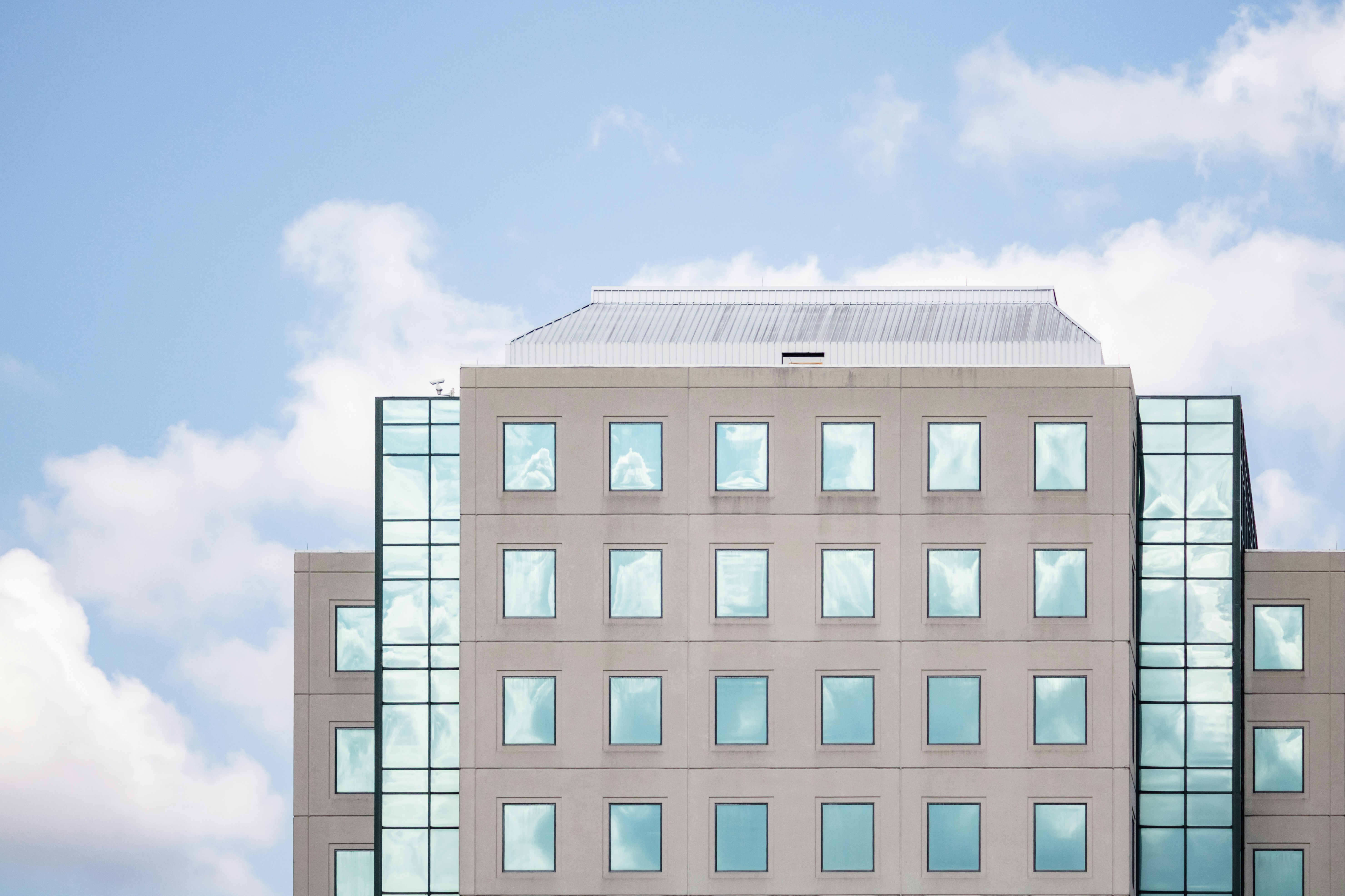 Symmetrical Glass Facade Rising Against a Clear Sky