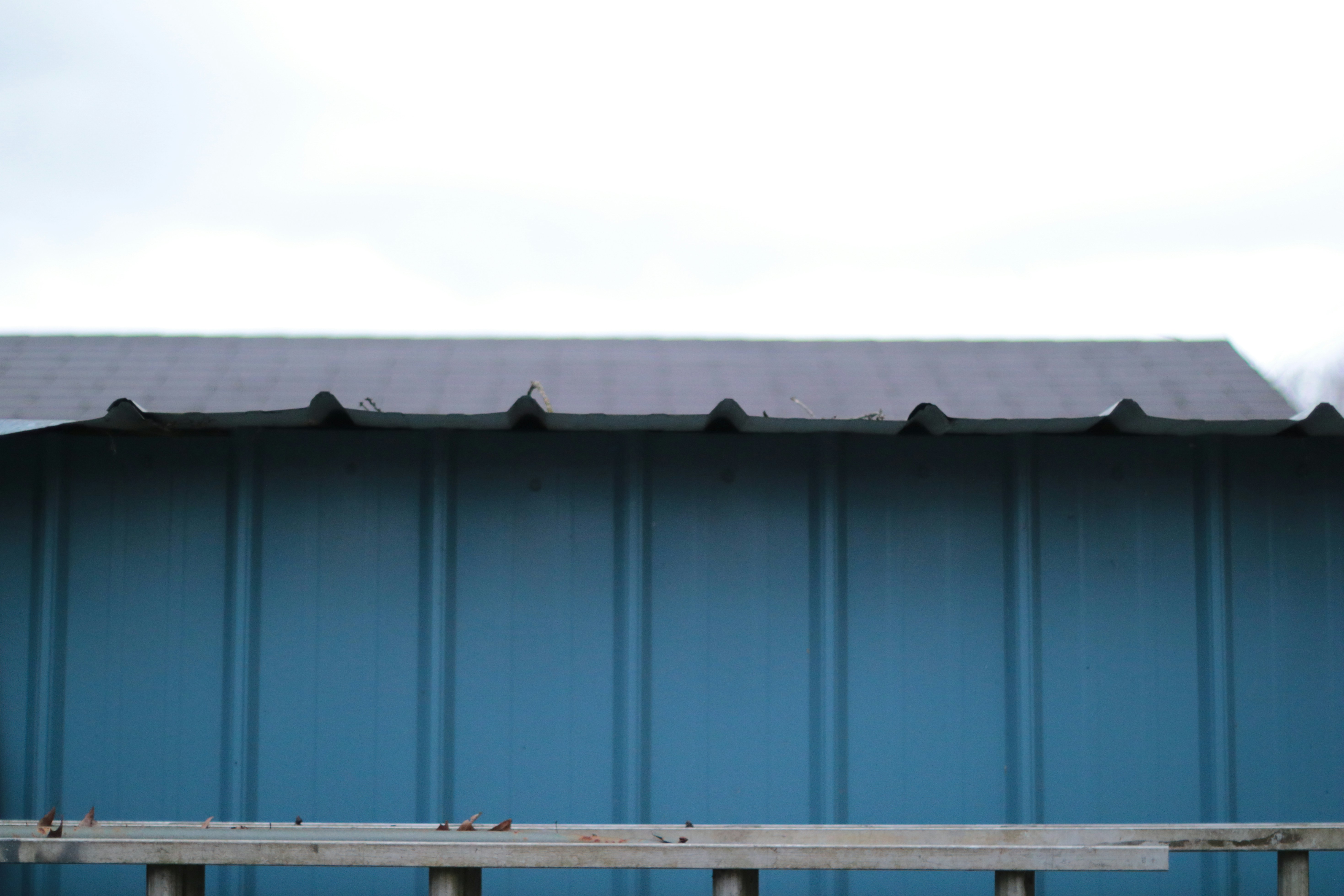Blue Shed Overlooking a Quiet Pier