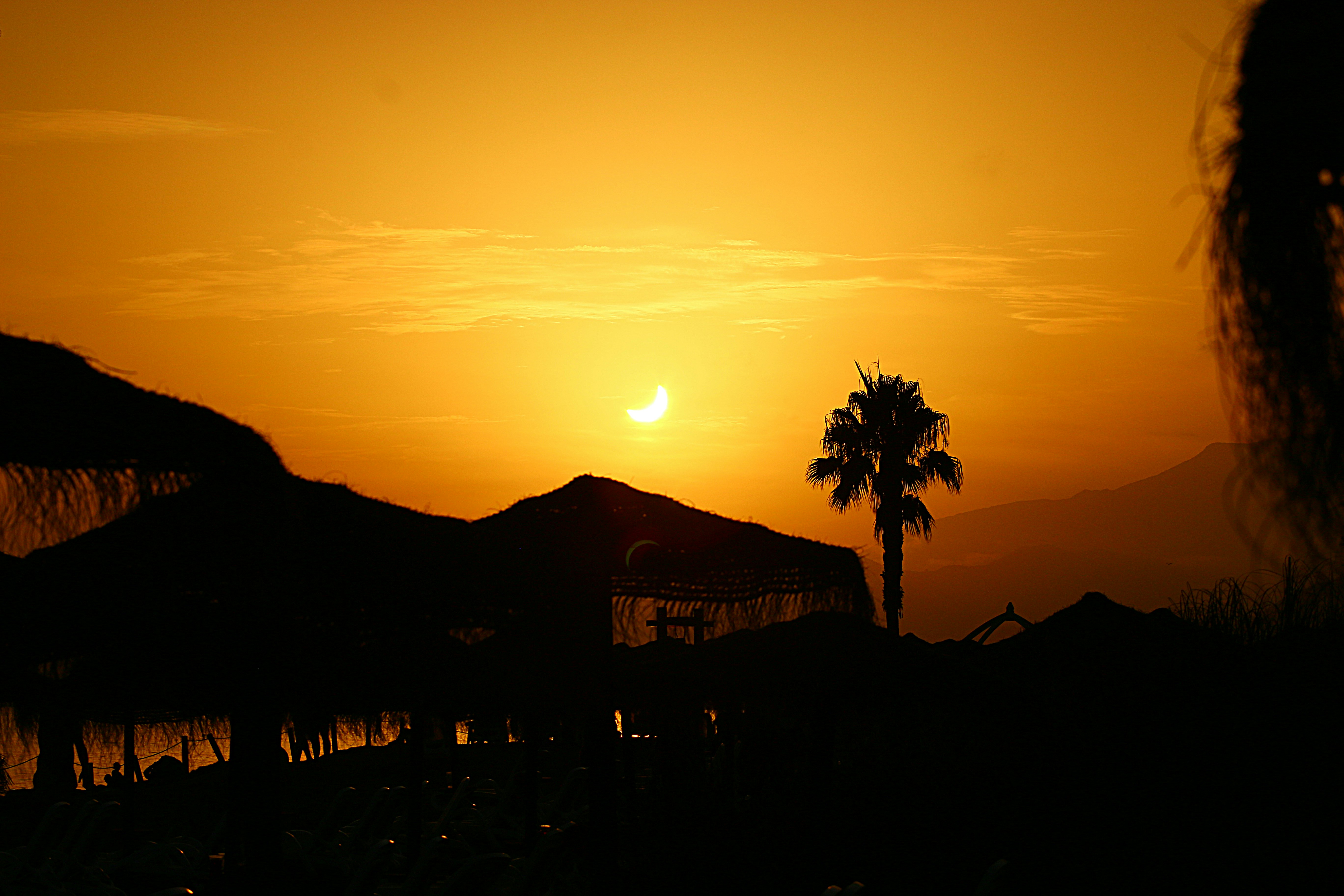 Sunset Silhouette Over a Calm Beach Village