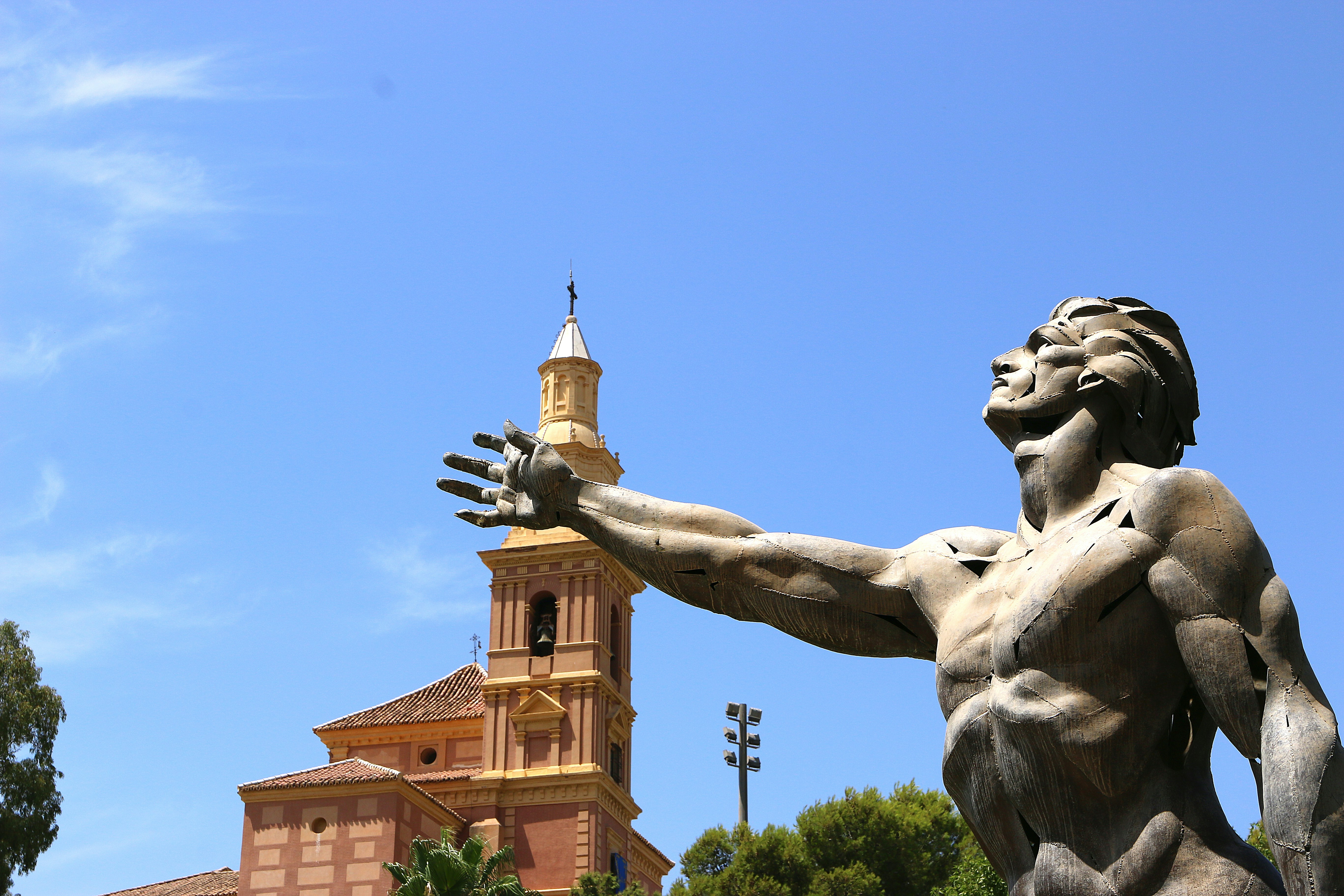 Outstretched Gaze: A Monumental Figure Overlooking a Florentine-Inspired Bell Tower