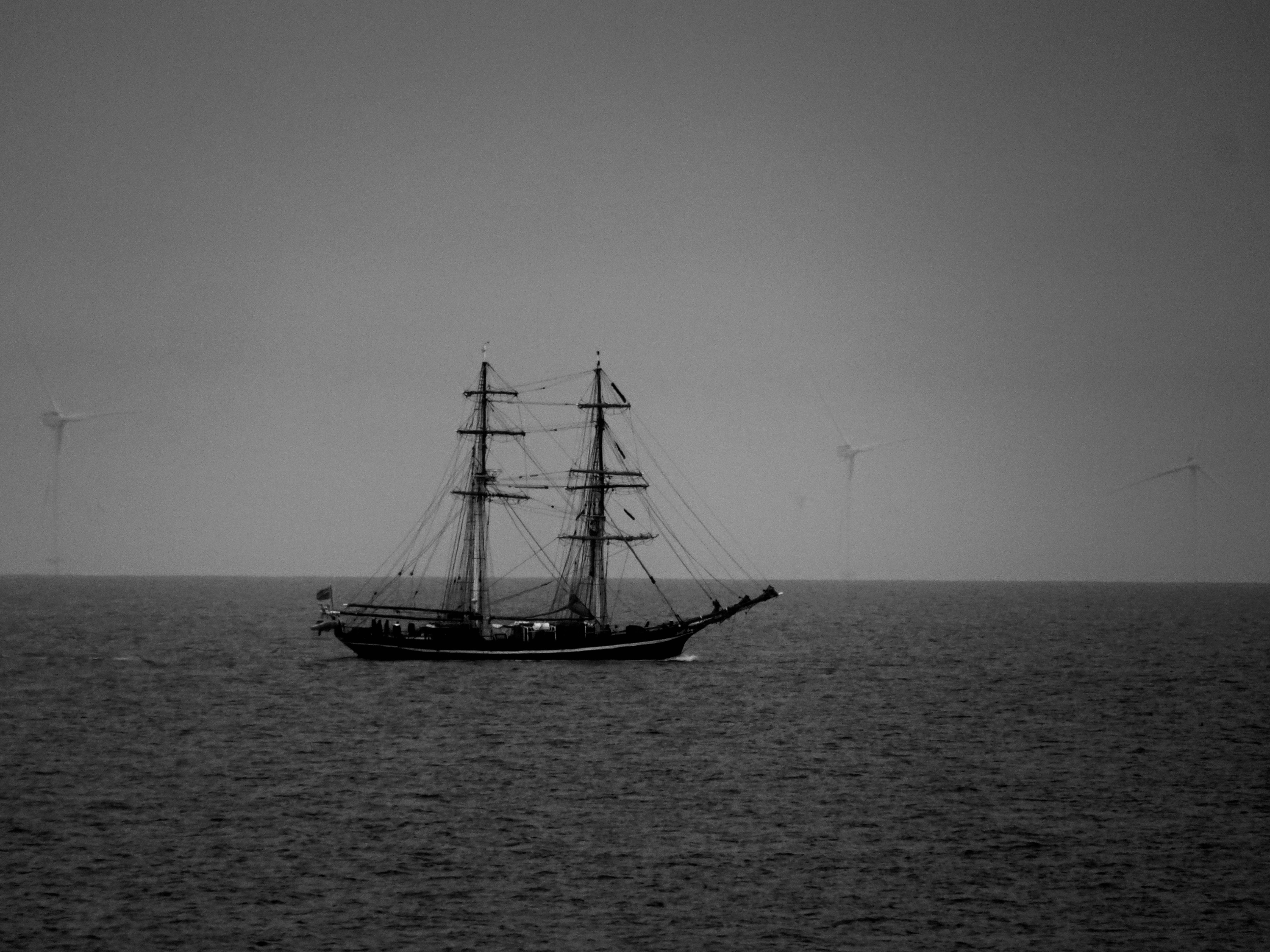 Midnight Sails: A Lone Clipper Across a Sober Horizon