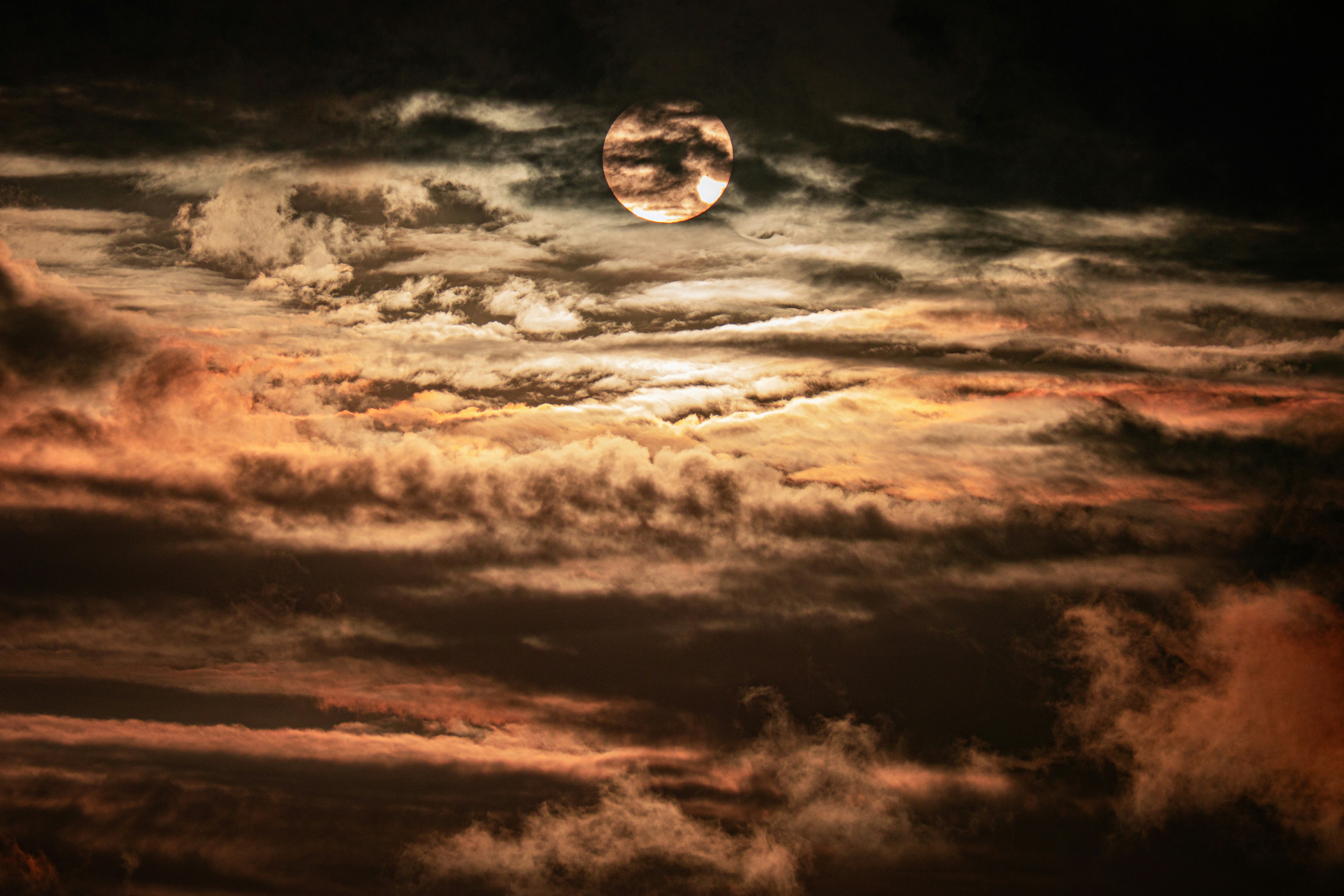 Luminous Moon Combing Through Veiled Clouds