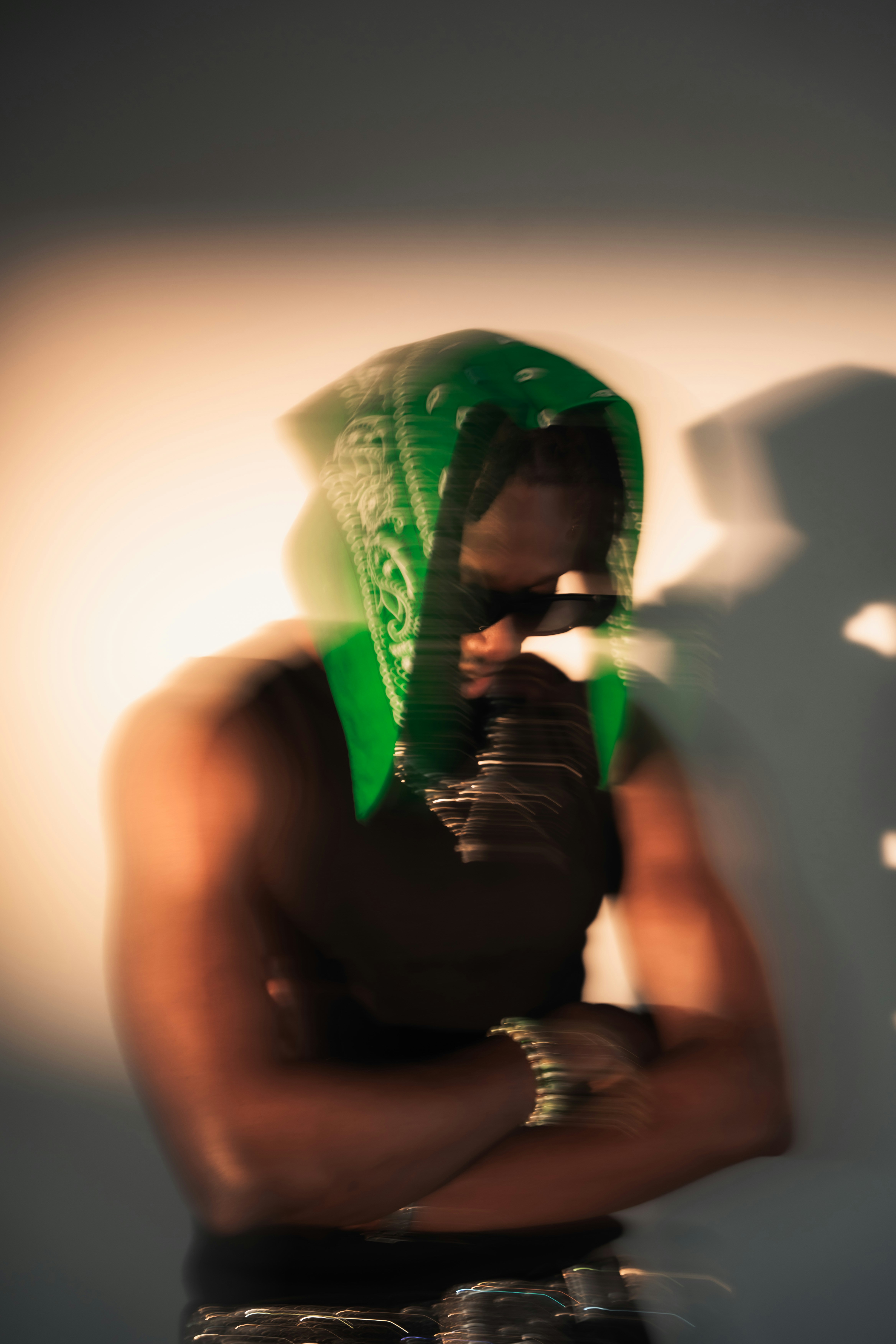 Green scarf silhouette: a blurred portrait in motion