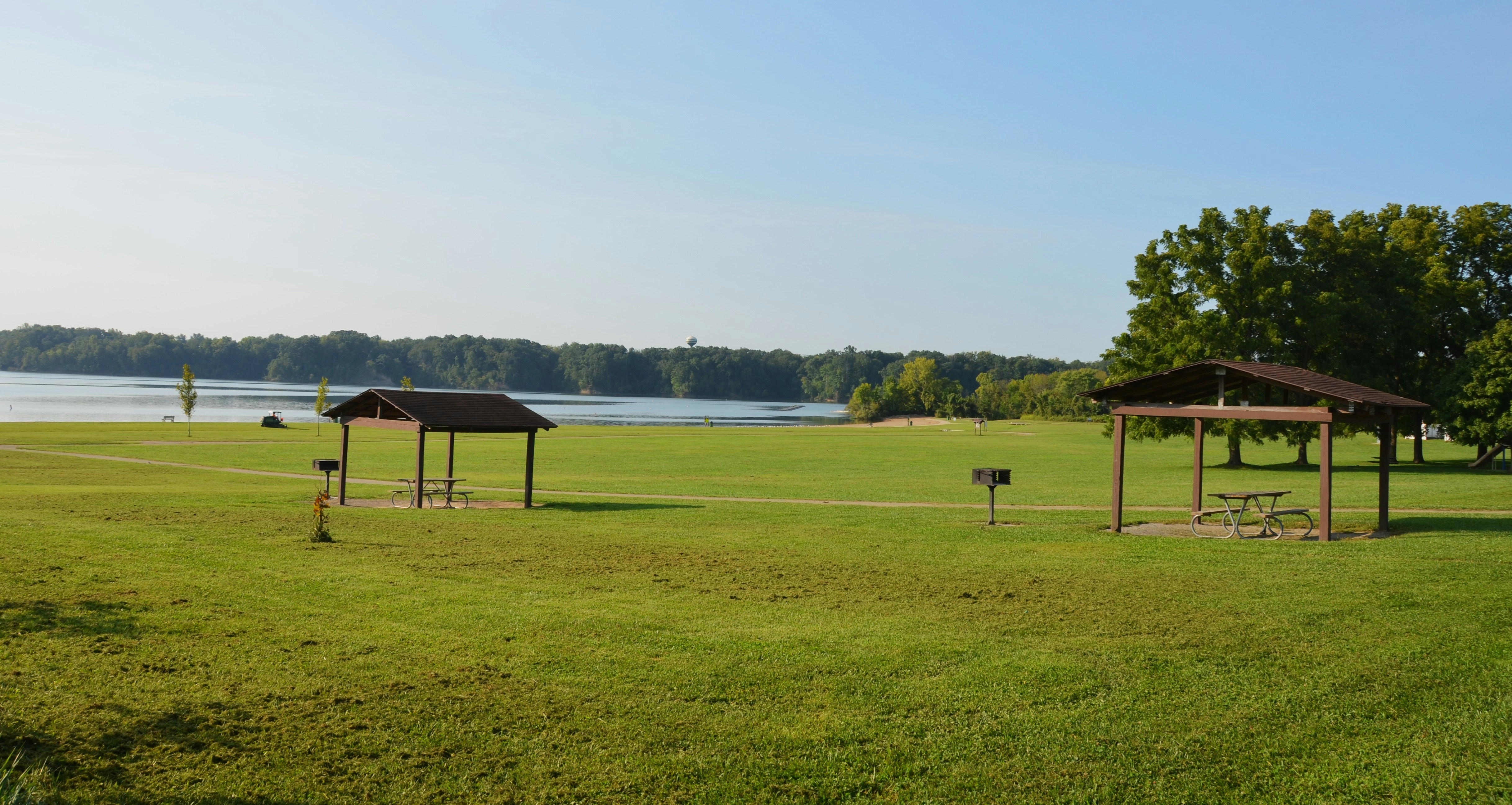 Quiet Lakeside Lawn with Pavilions Under a Clear Sky