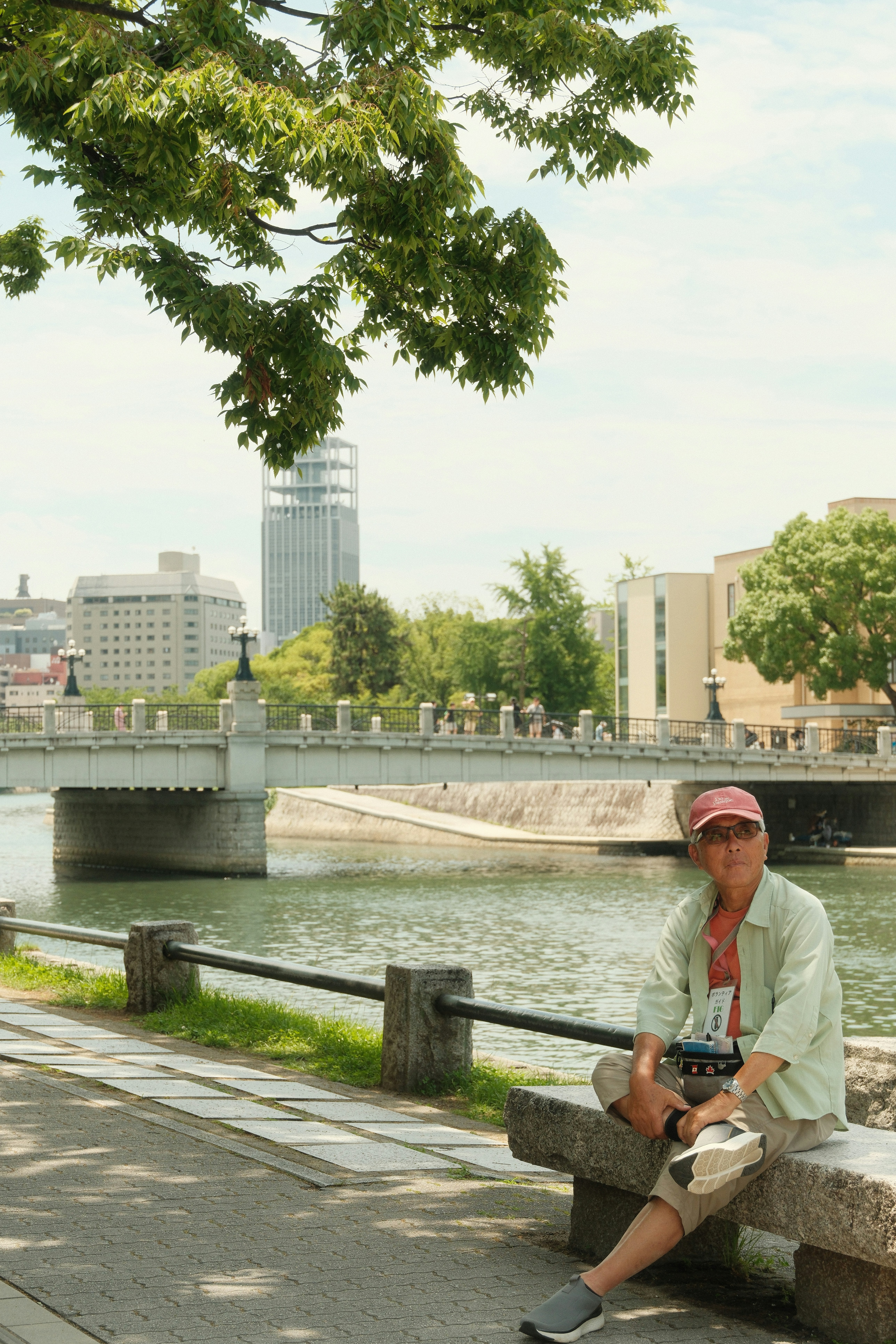 City Riverside Portrait: A Quiet Moment by the Water with a Sunhat and Canonical Bridge