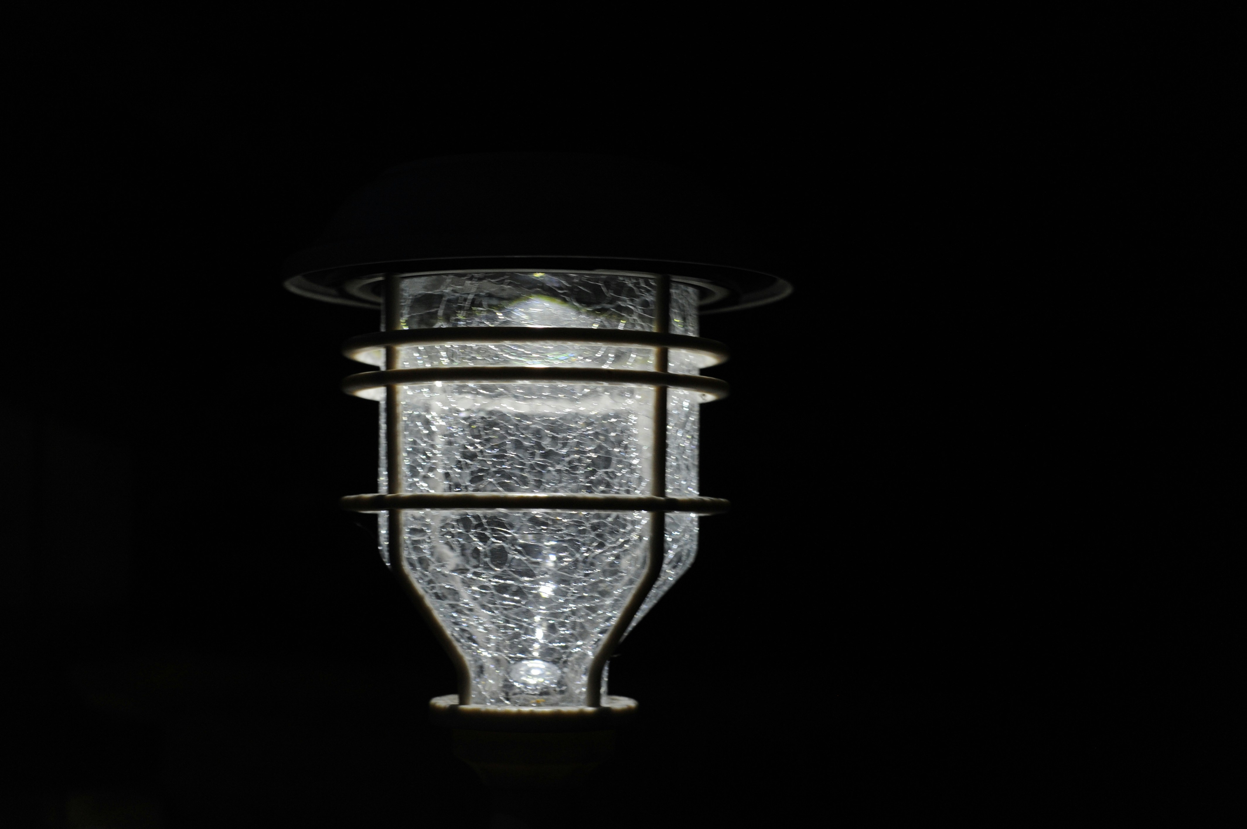 Caged Glow: An Industrial Flame Within the Night