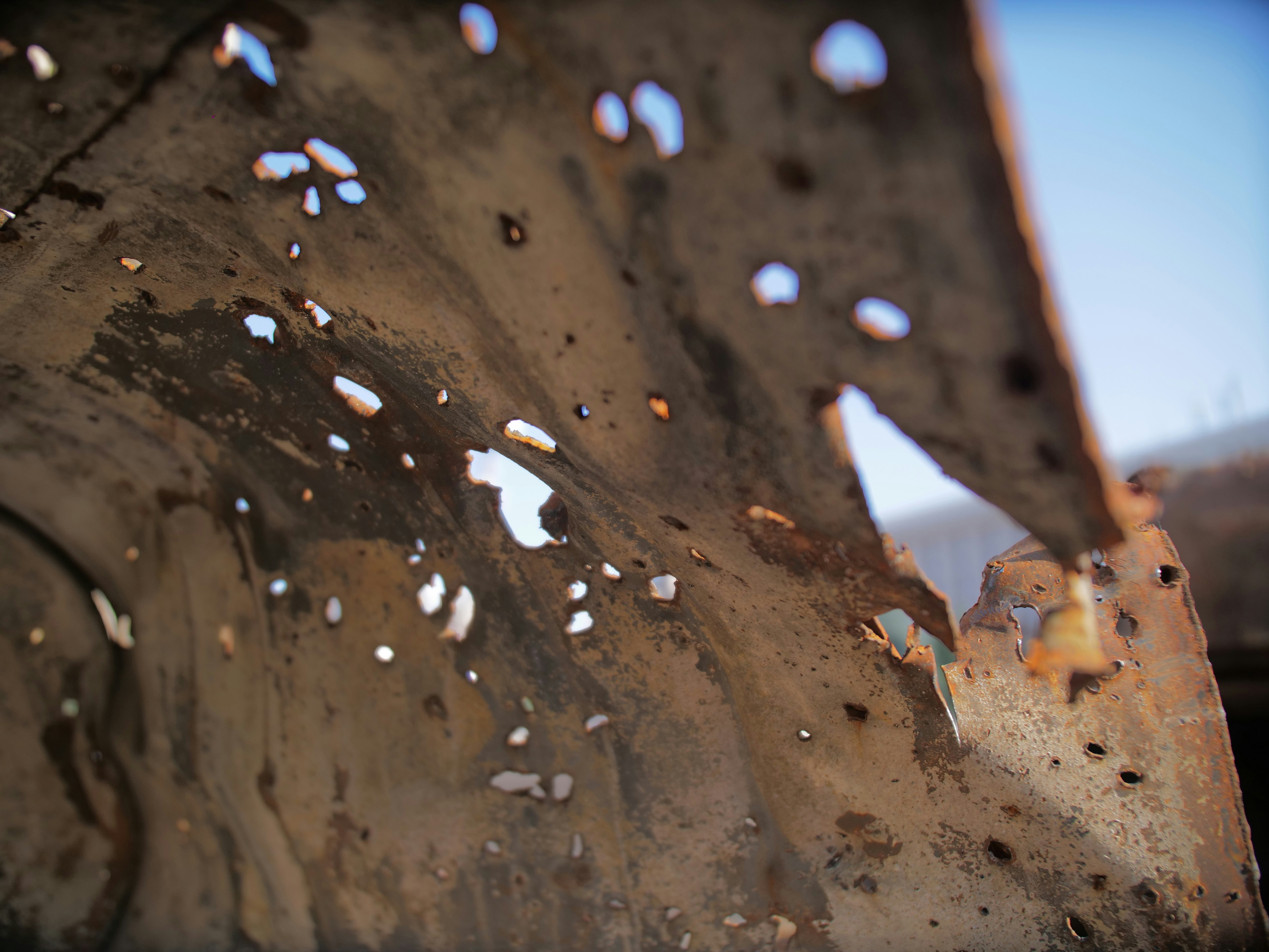Rusted Lattice of Time: Holes and Light in a Corroded Structure