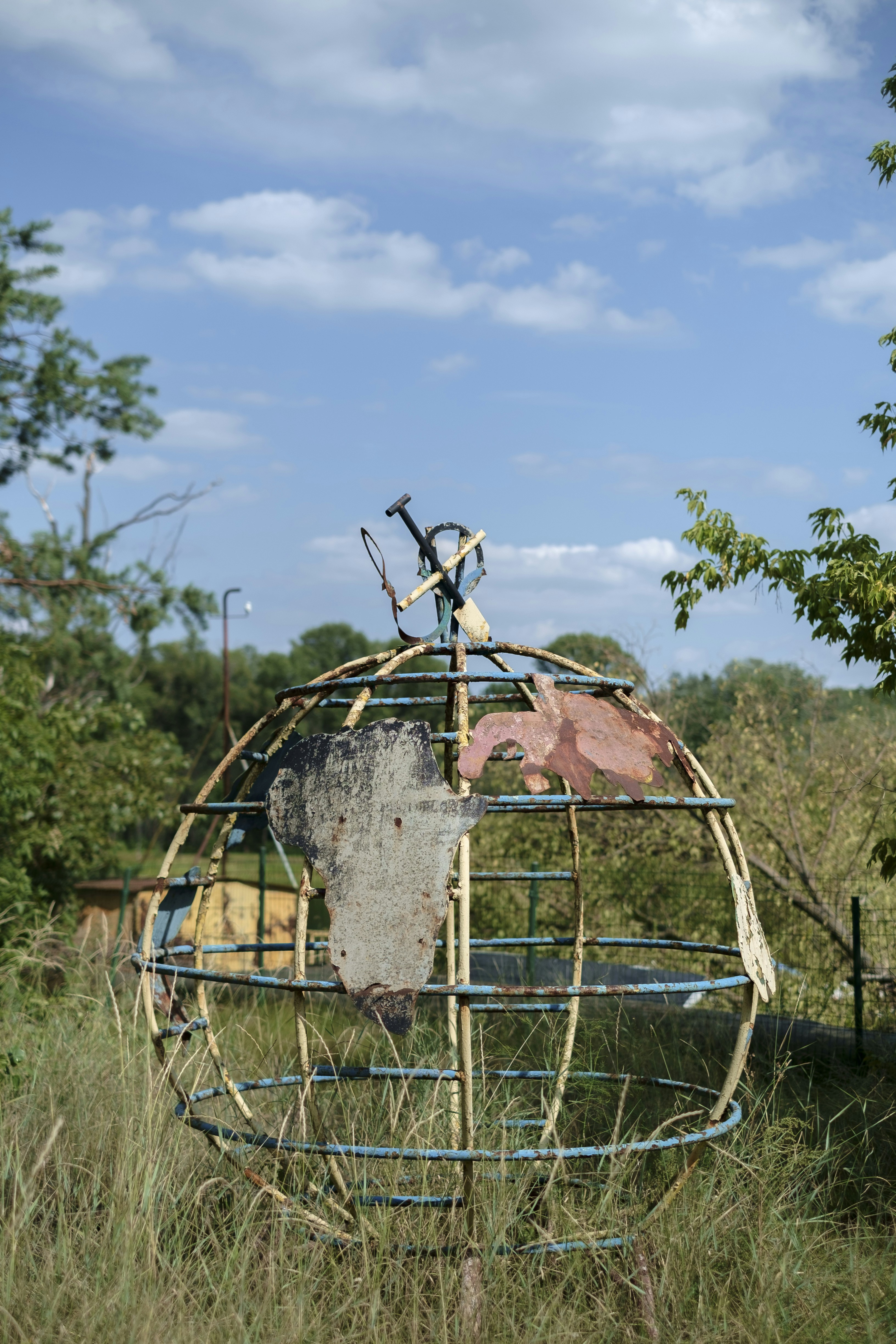 Rusting Globe: a grassy farewell to a forgotten playground