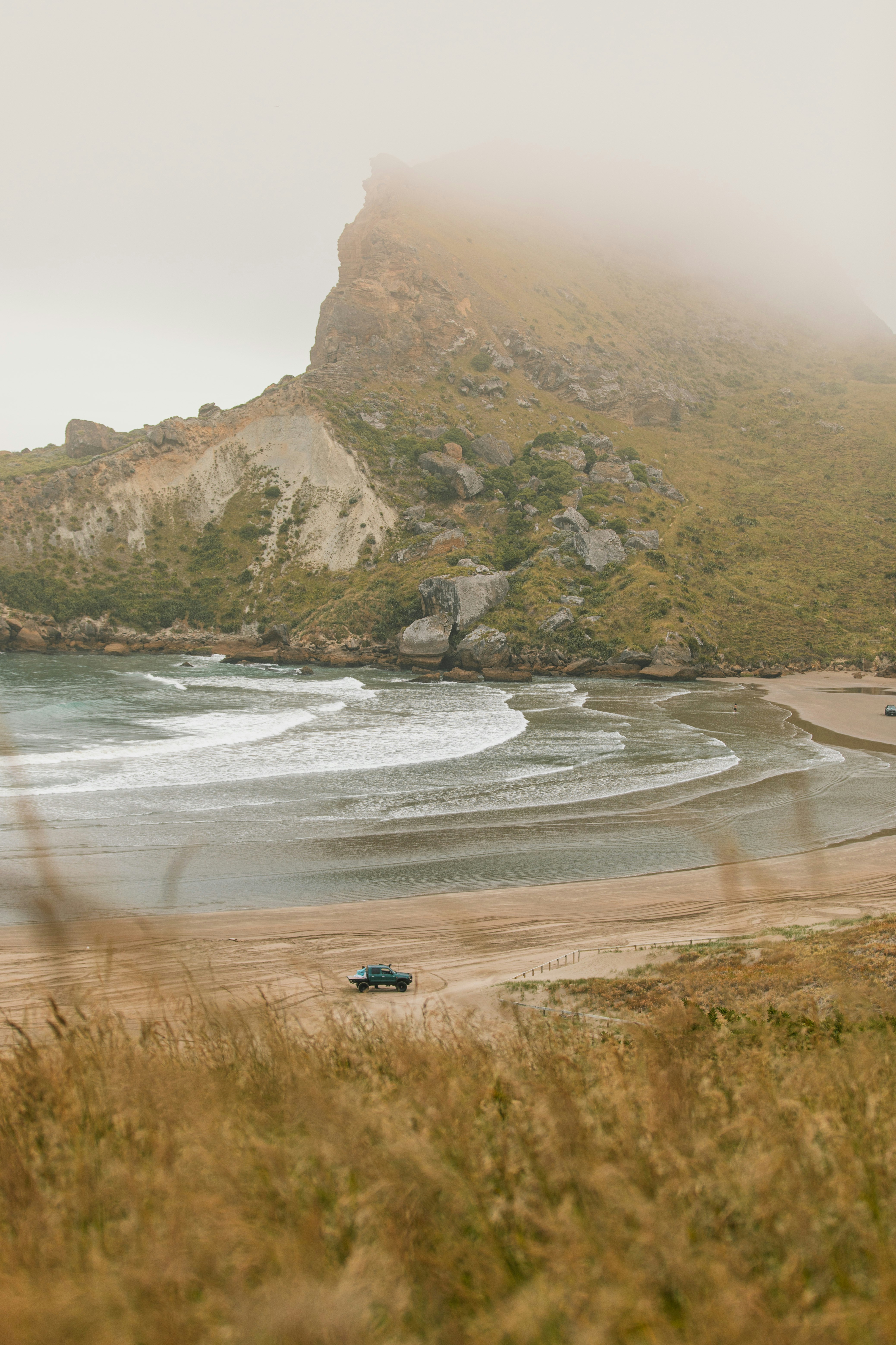 Lonely Jeep at the Foot of the Misty Cliffs