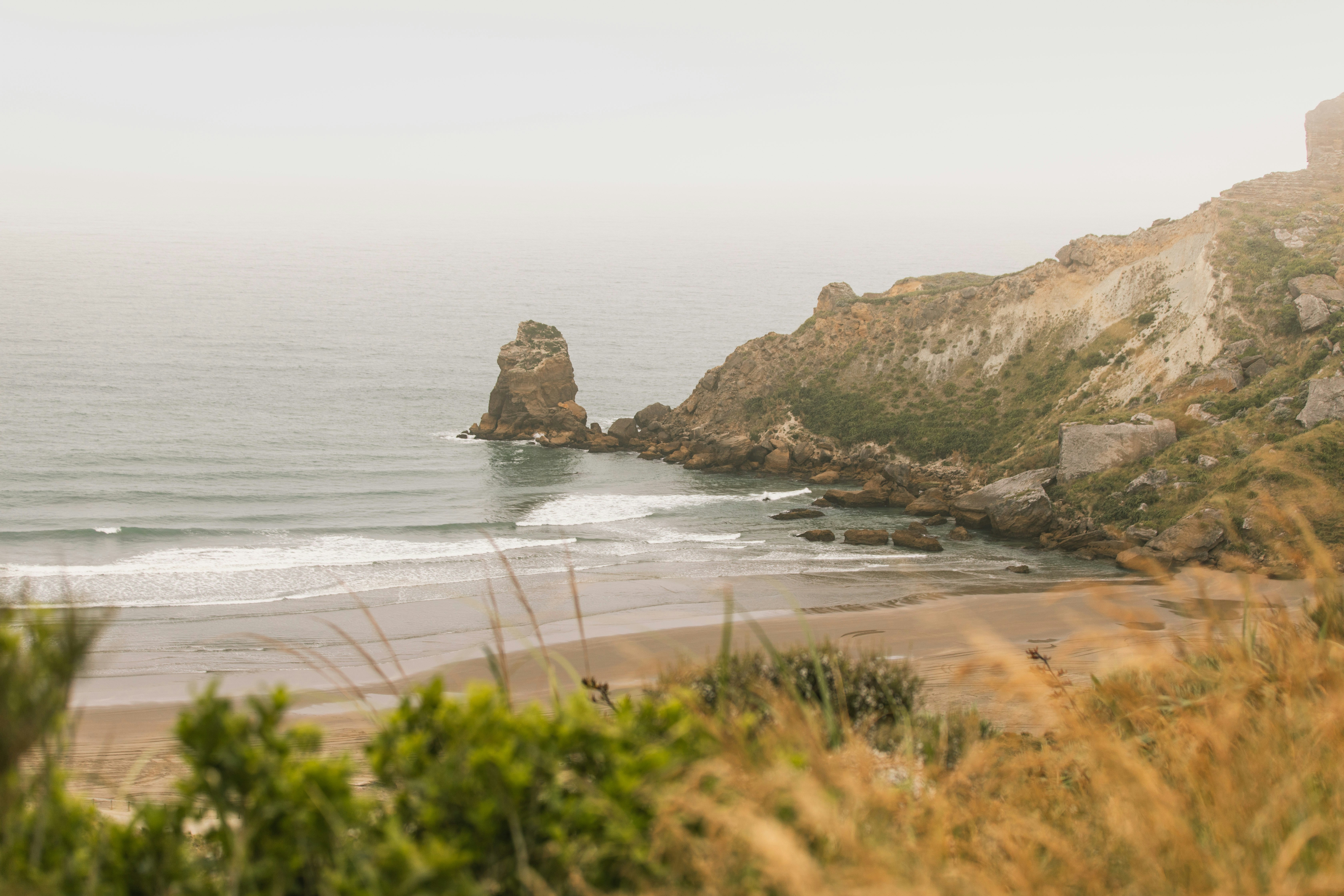 Coastal Cliffs at Dusk: Quiet Sea Meeting a Rugged Shore