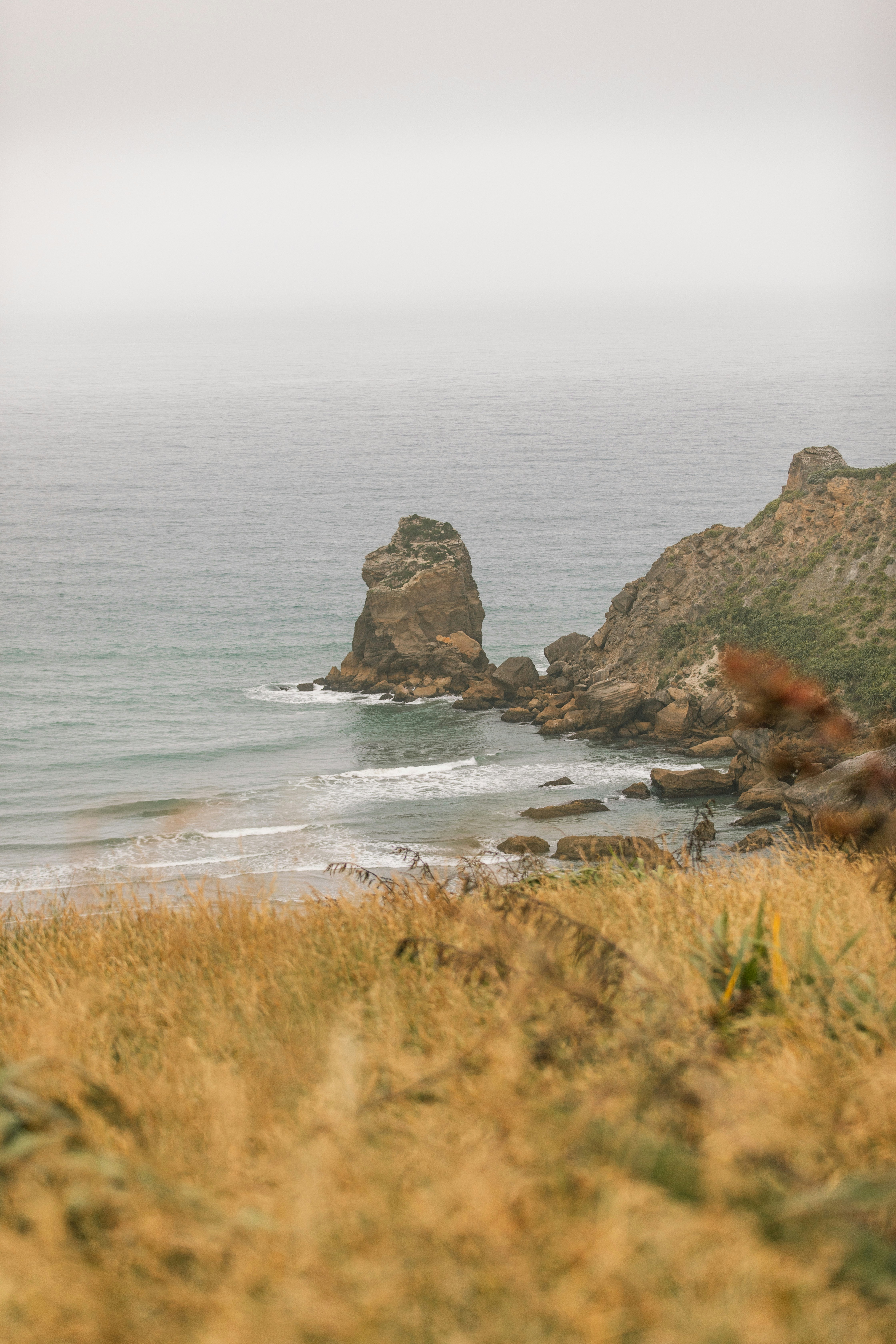 Sea Cliff Sentinel: The Prominent Rock Amid Gentle Waves