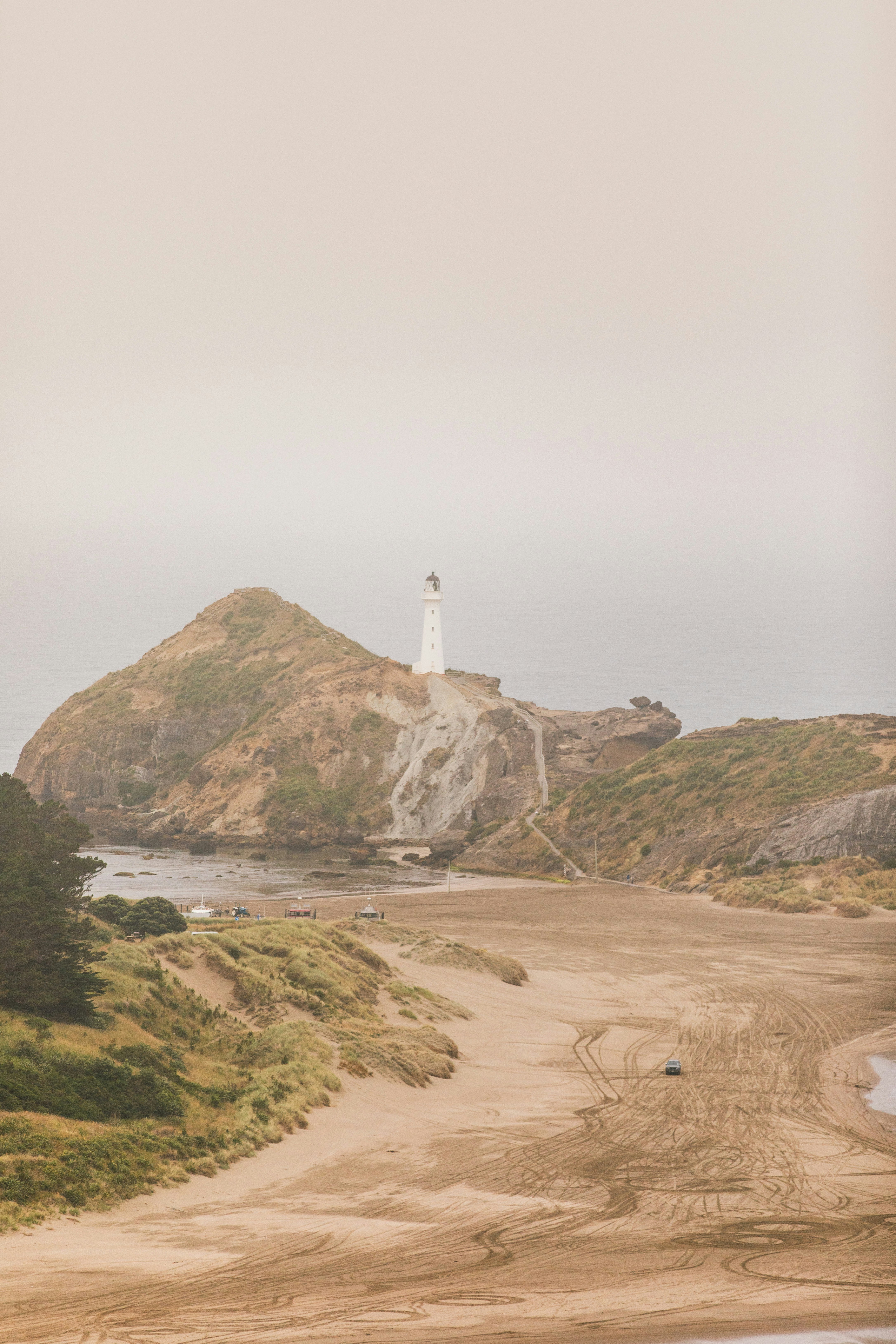 Lighthouse Sentinel: A Cresting Cliff and Quiet Beach