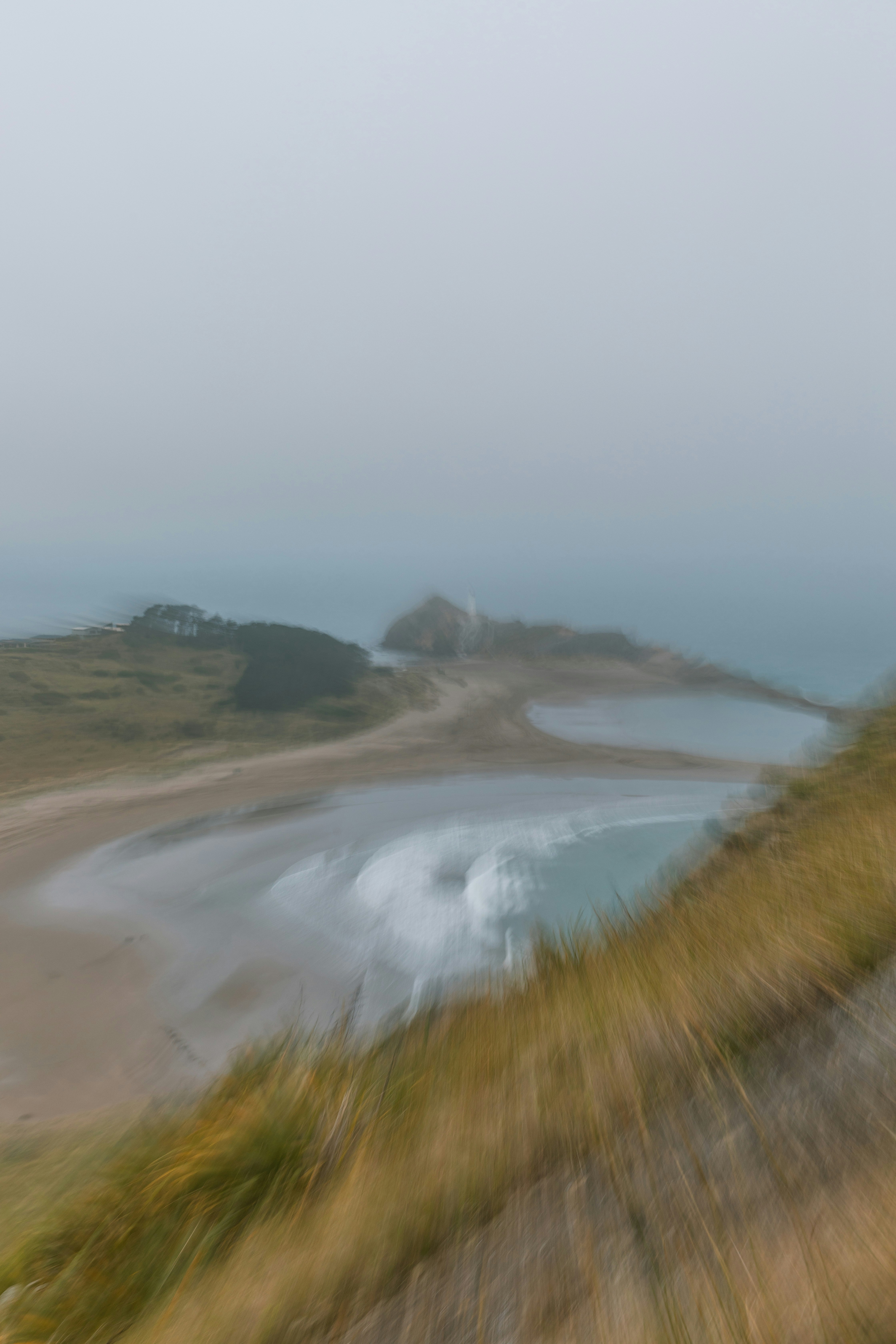 Mist on the Clifftop Beach: A Blurred Quiet