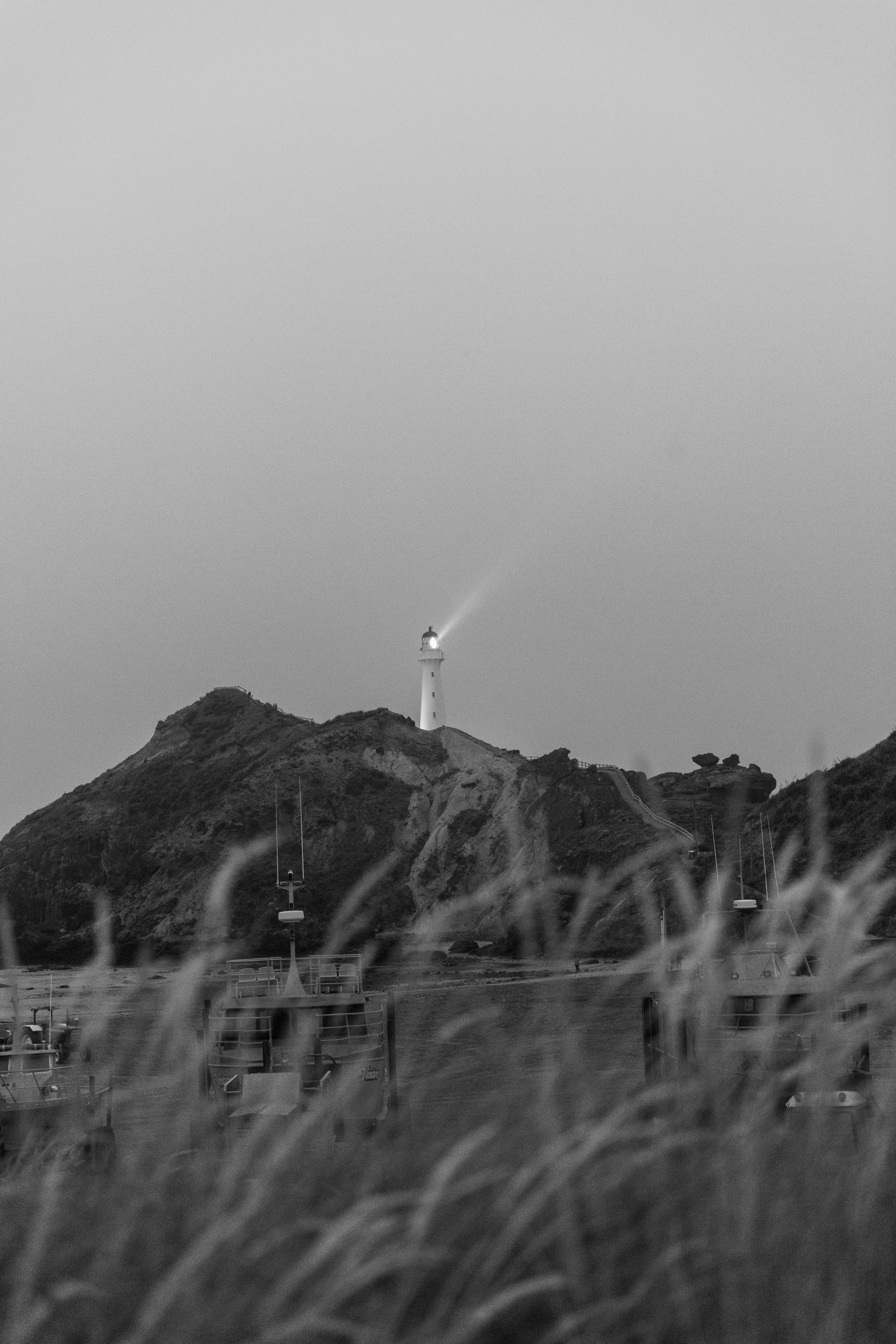 Lighthouse Sentinel: Quiet Coastline Under Gray Skies