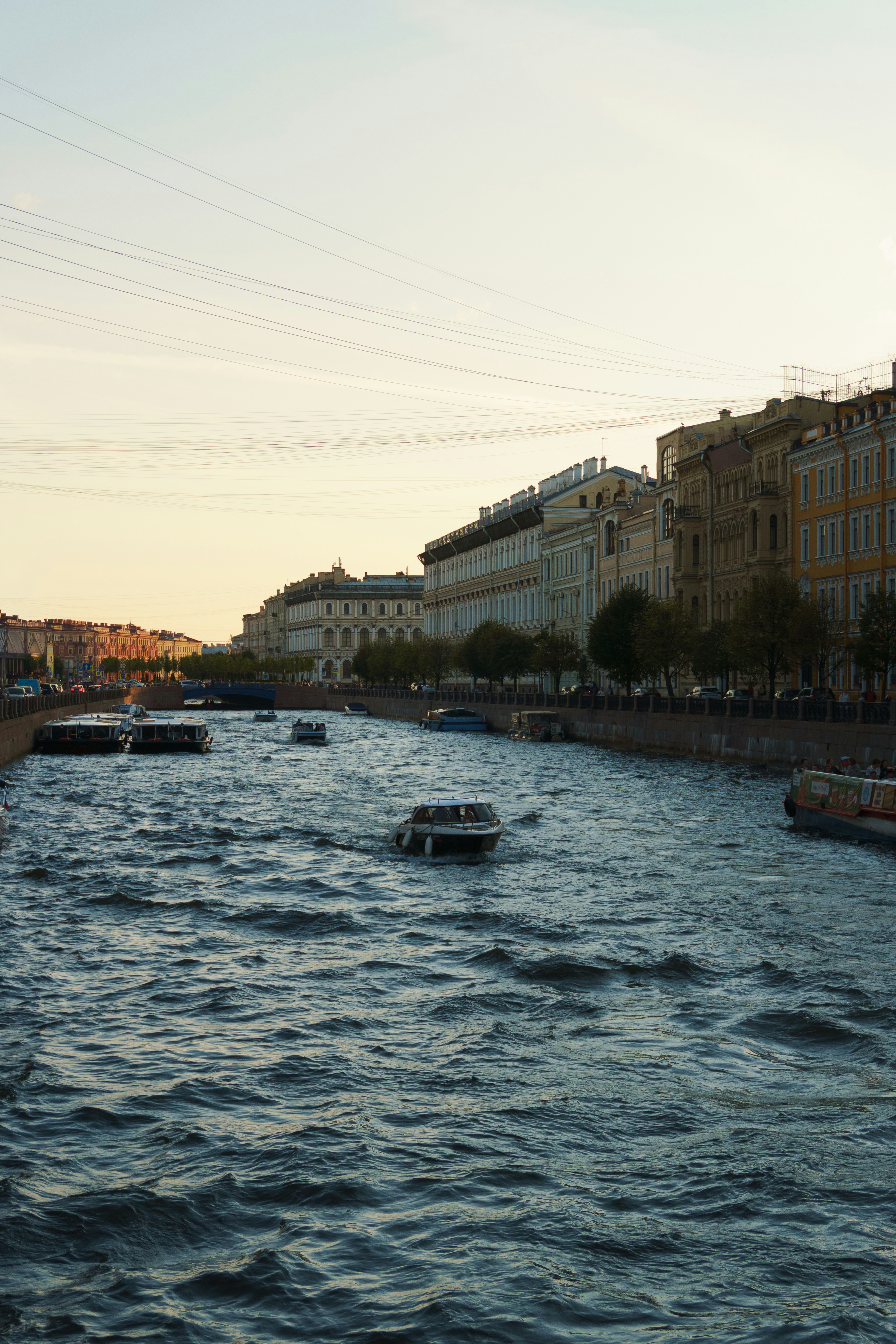 Sunset Over the Canal: City Buildings, Boats, and Water in Motion