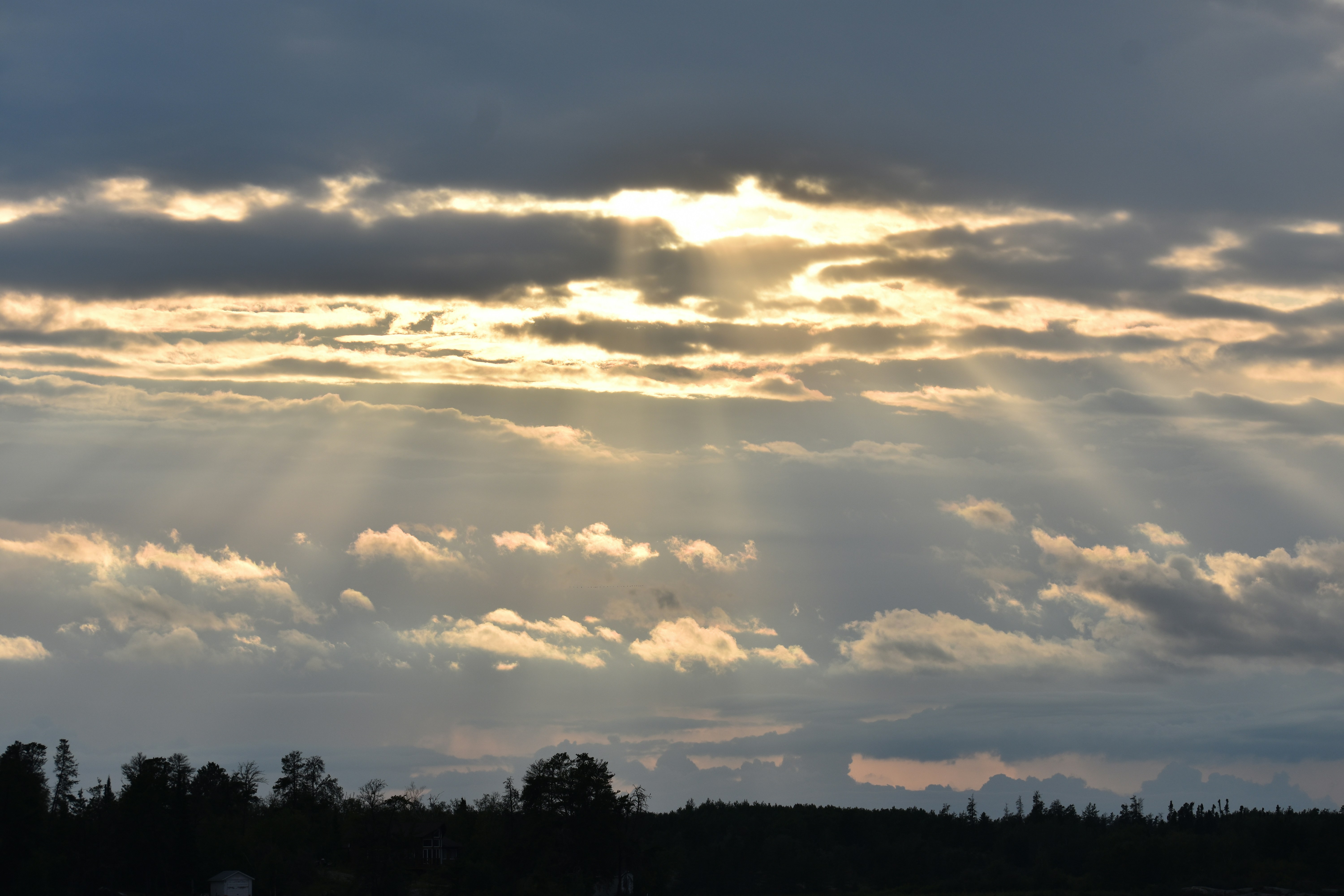 Dawn’s Gentle Divide: Sunbeams Through a Quiet Horizon