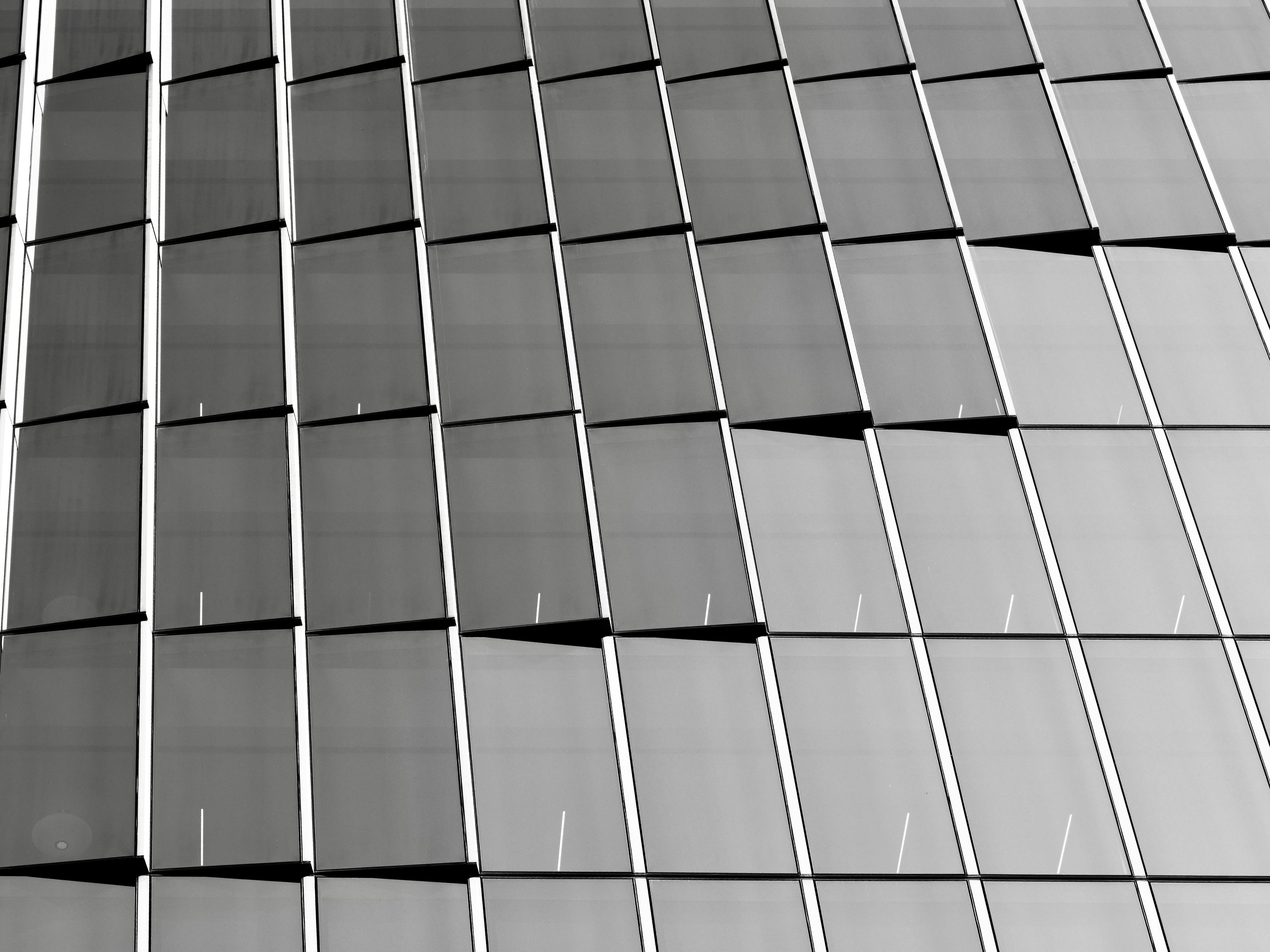 Vertical Glass Quilt: A Grid of Reflections on Facade Panels