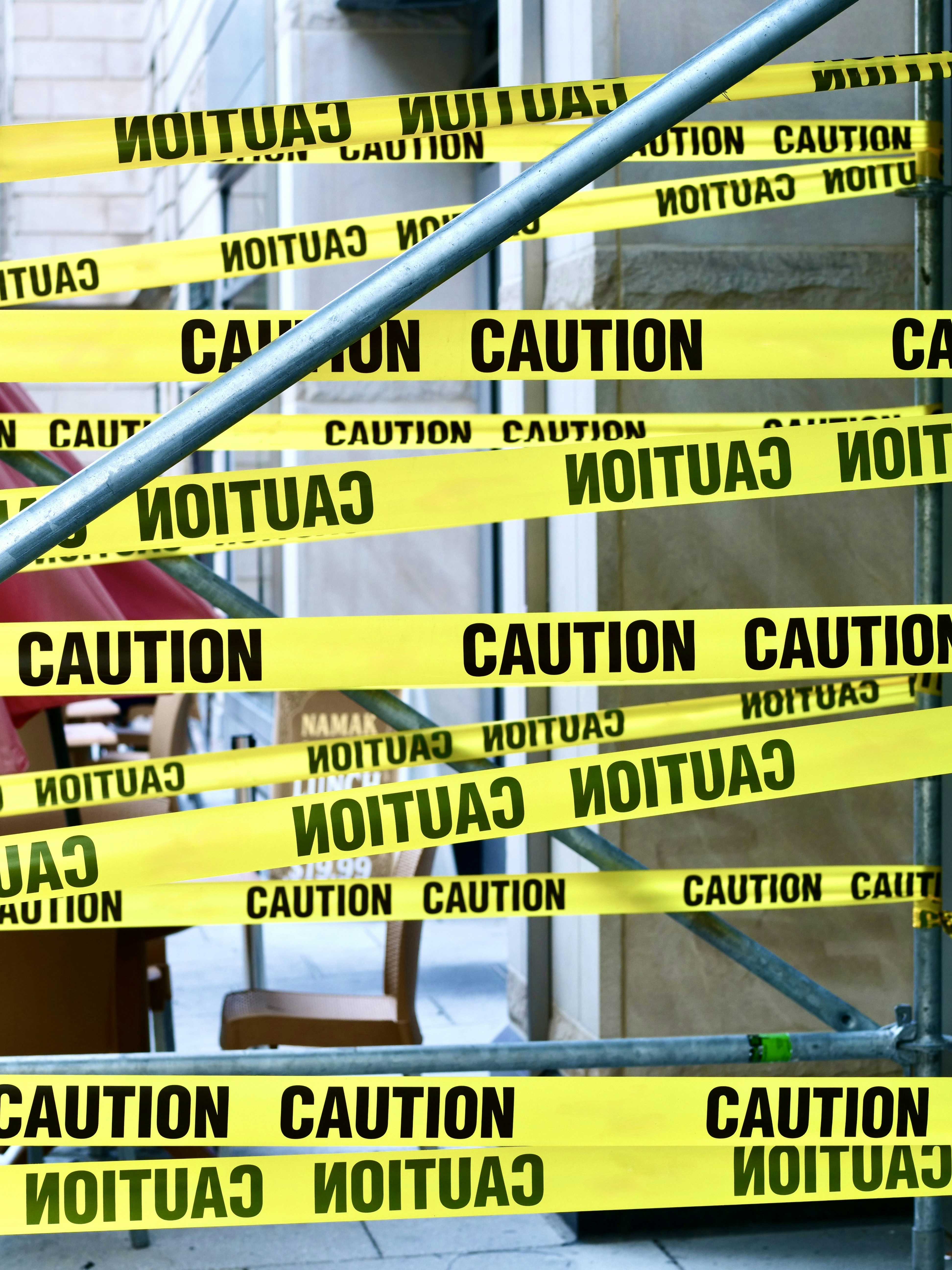 Caution Tangle: Yellow Tape Framing a Scene of Interruption