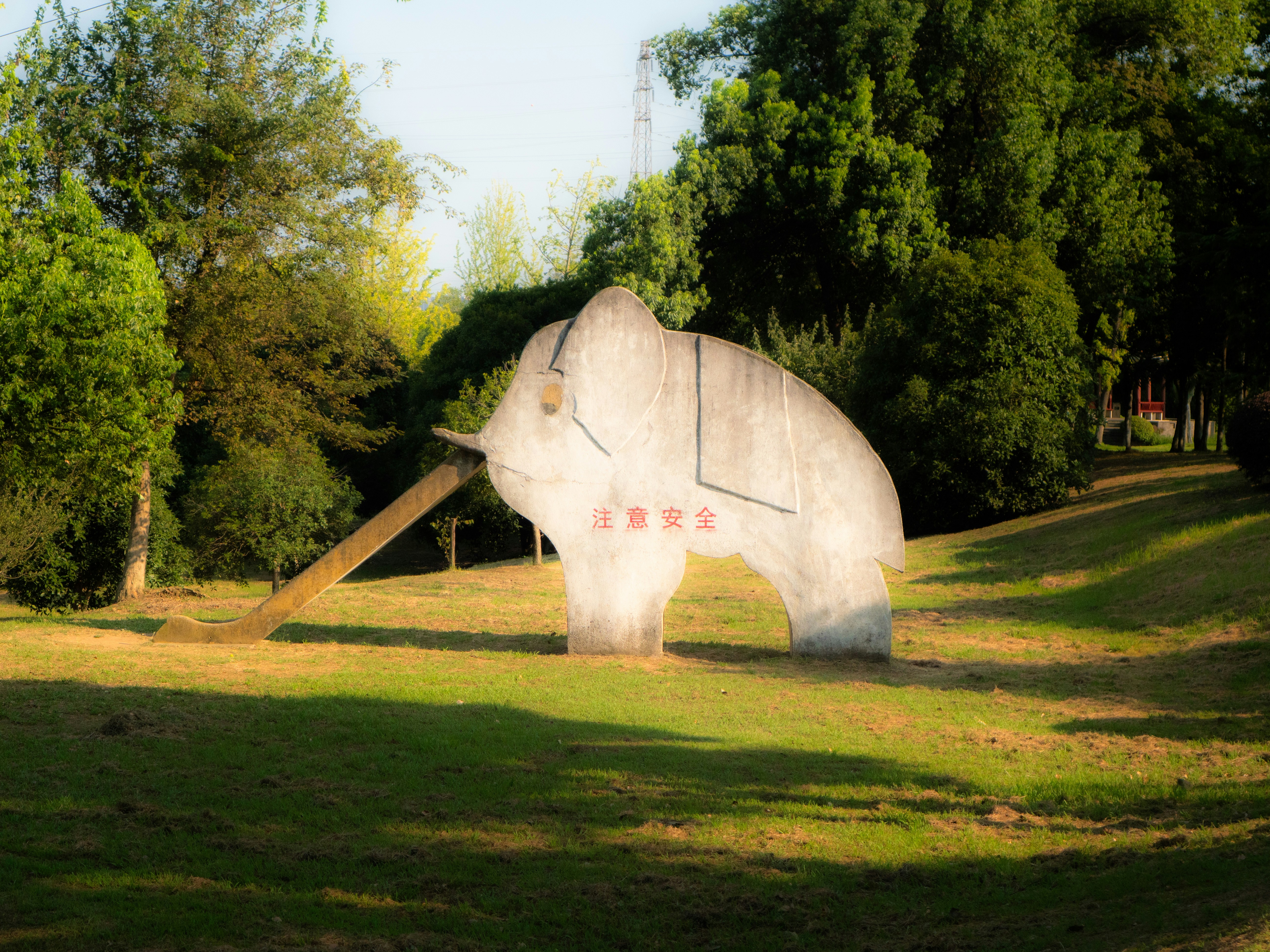 Ancient Elephant Monument in Dappled Park Light