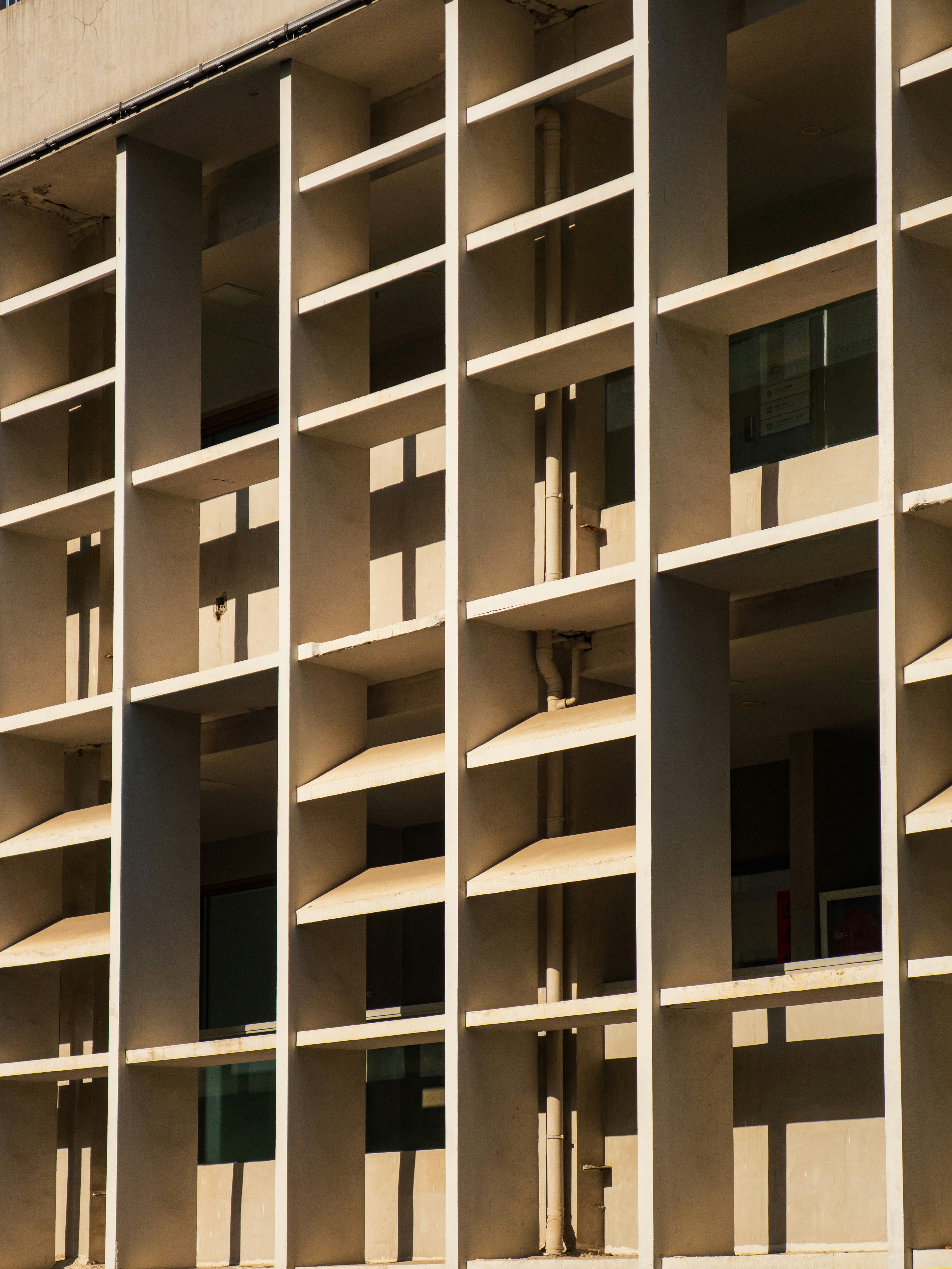 Grid of Shadows: A Sunlit Facade of Repeated Concrete Geometry