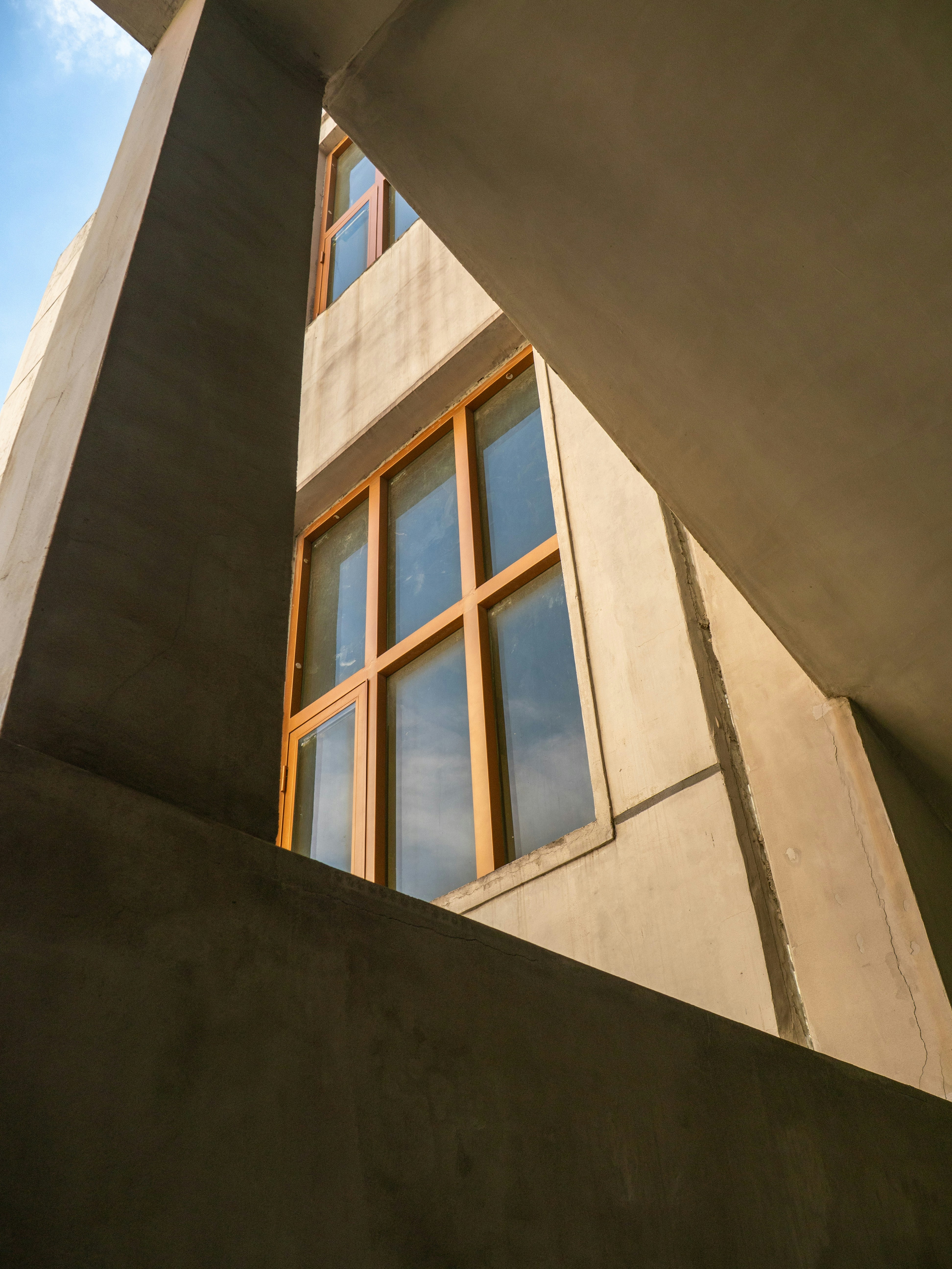 Architectural Light: Framed Windows Amid Concrete Arches