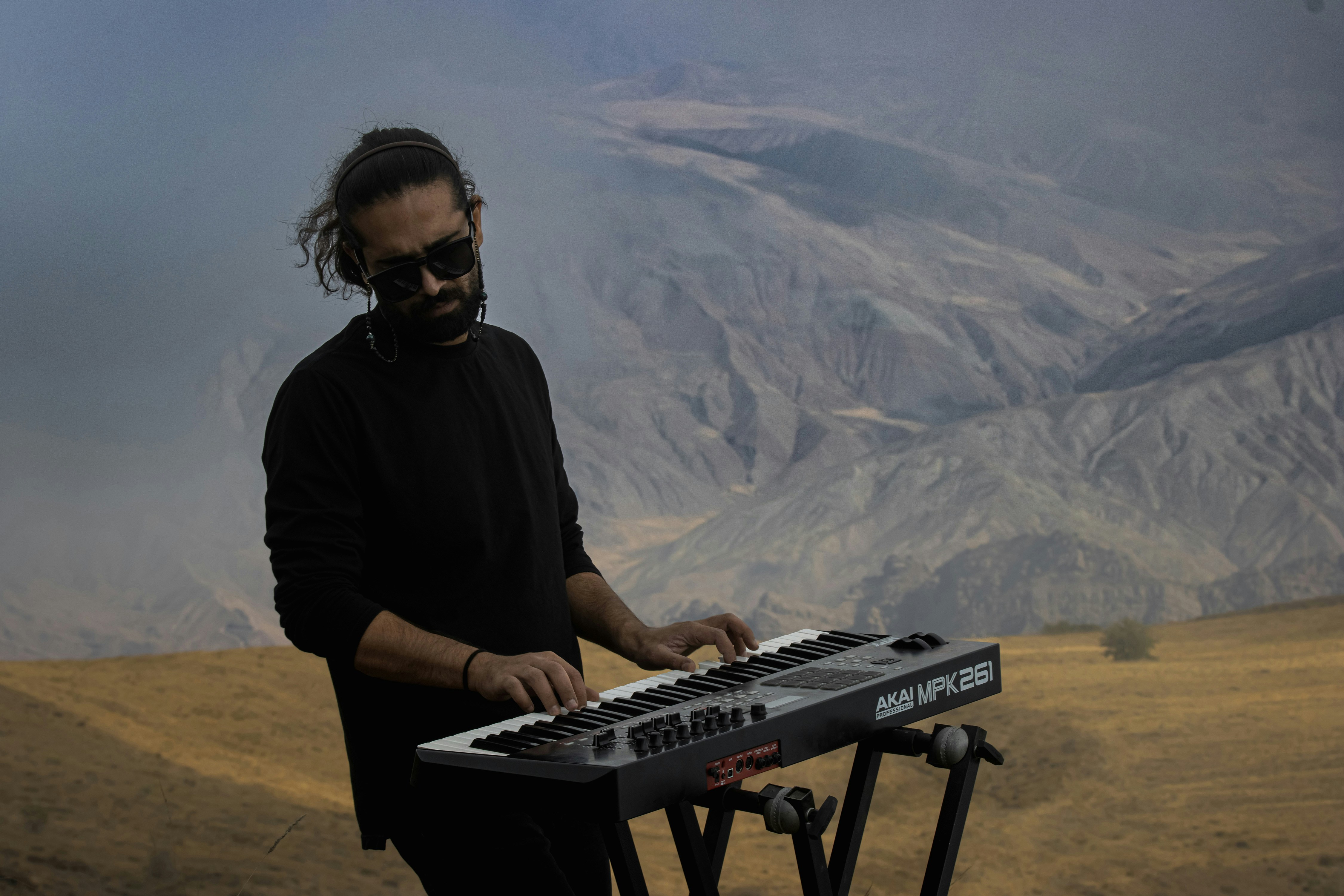 Desert Soundscape: Musician at the Keyboard Amid Distant Dunes