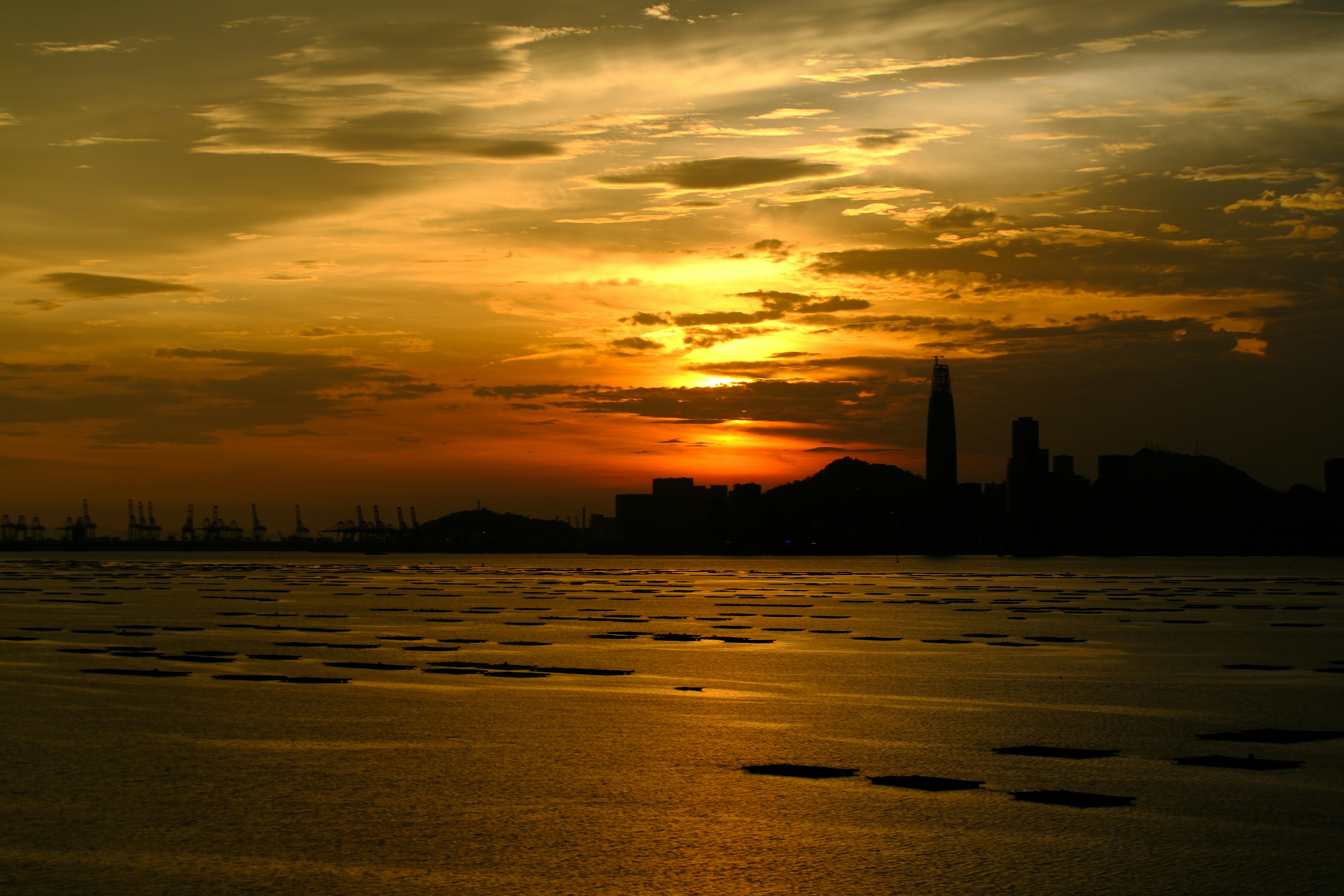 Sunset Silhouette Over a Calm Harbor