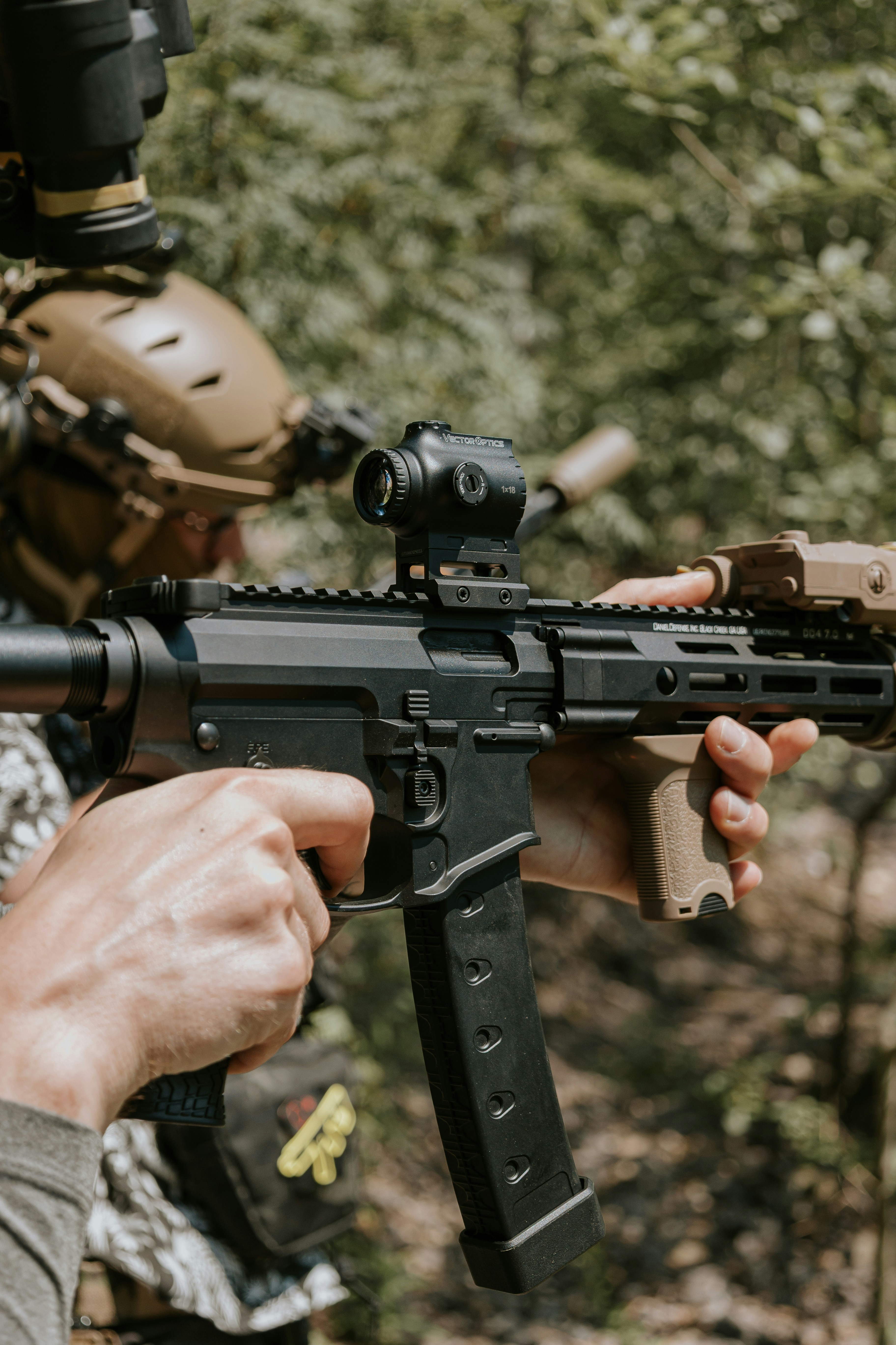 Close-up on Firearm Handling: Scoped Rifle Ready for Field Duty