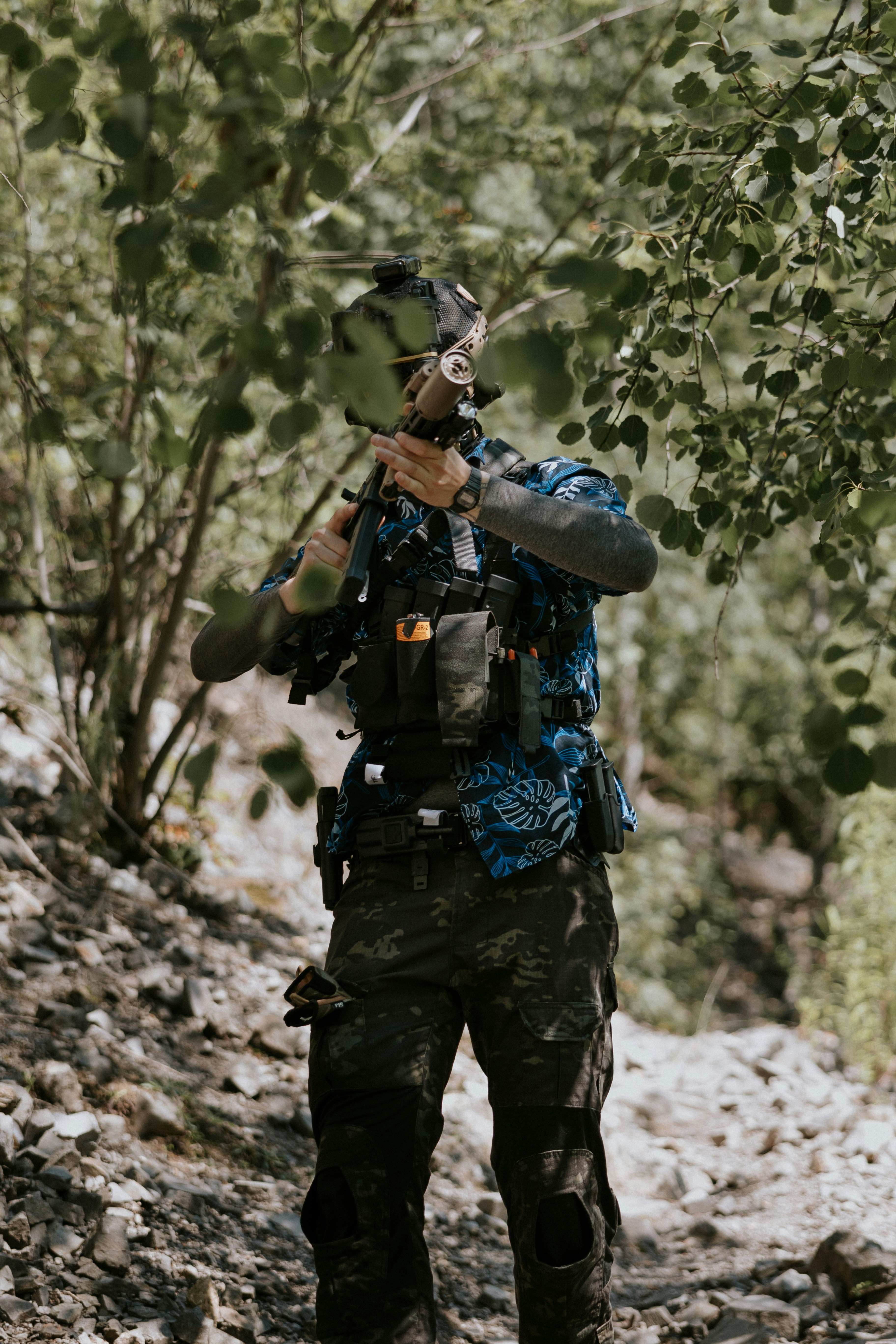 Masked marksman in a shadowed forest clearing